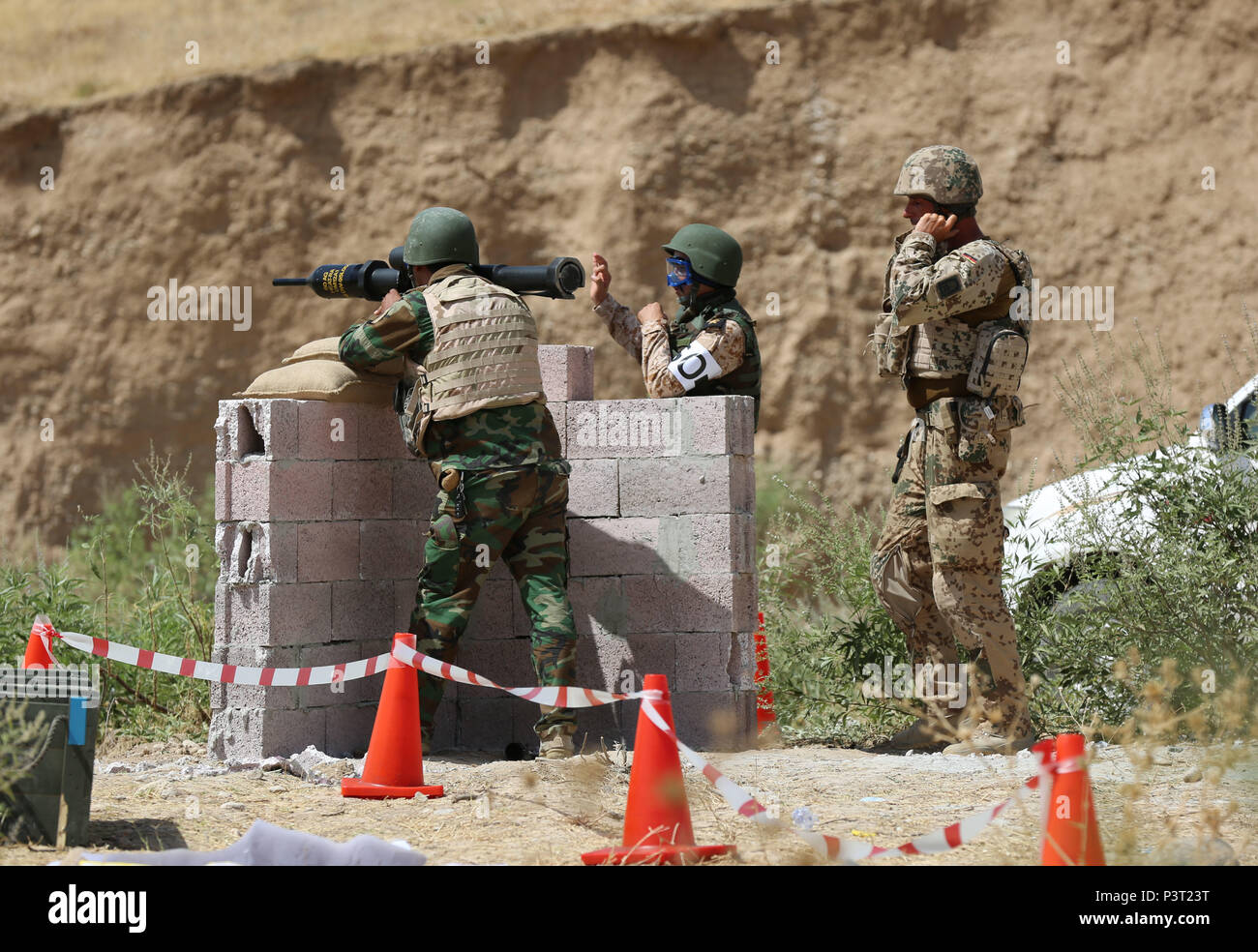 A German instructor observes Peshmerga soldiers as they prepare to fire ...