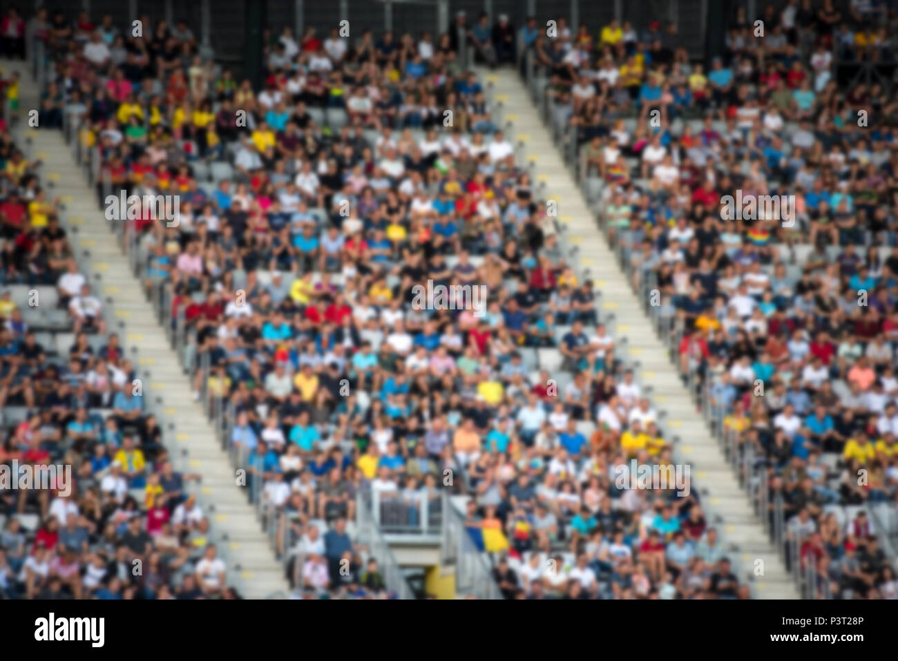 Blurred crowd of spectators in a stadium tribune at a football match ...