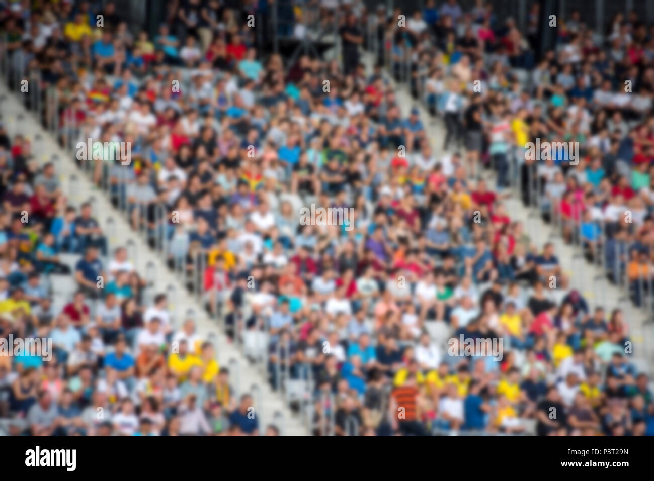 Blurred crowd of spectators in a stadium tribune at a football match ...