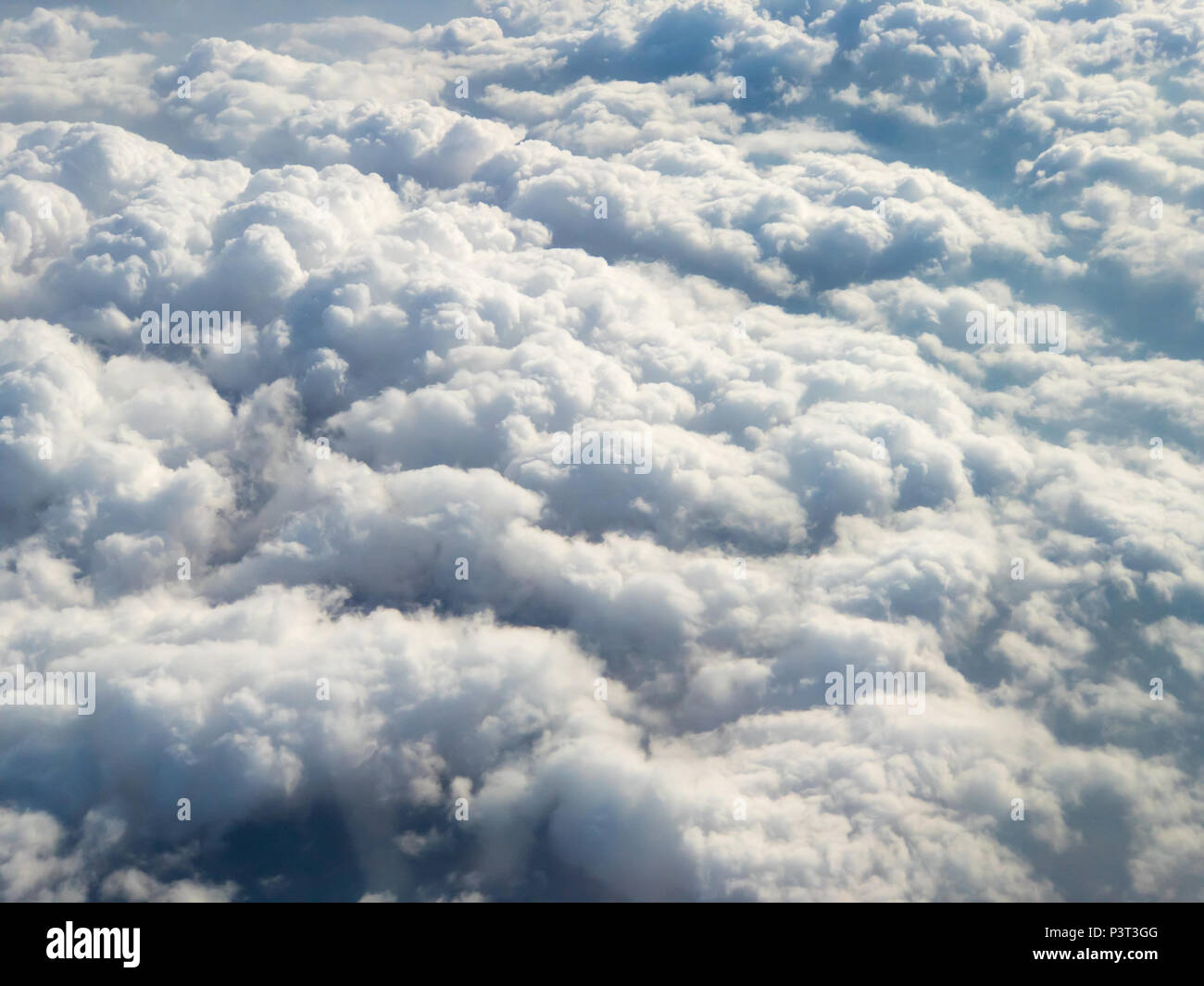 Flying above the clouds by airplane Stock Photo - Alamy