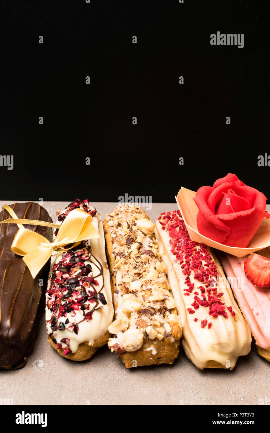 Sweet delicious colorful french eclairs. Group of french dessert ...