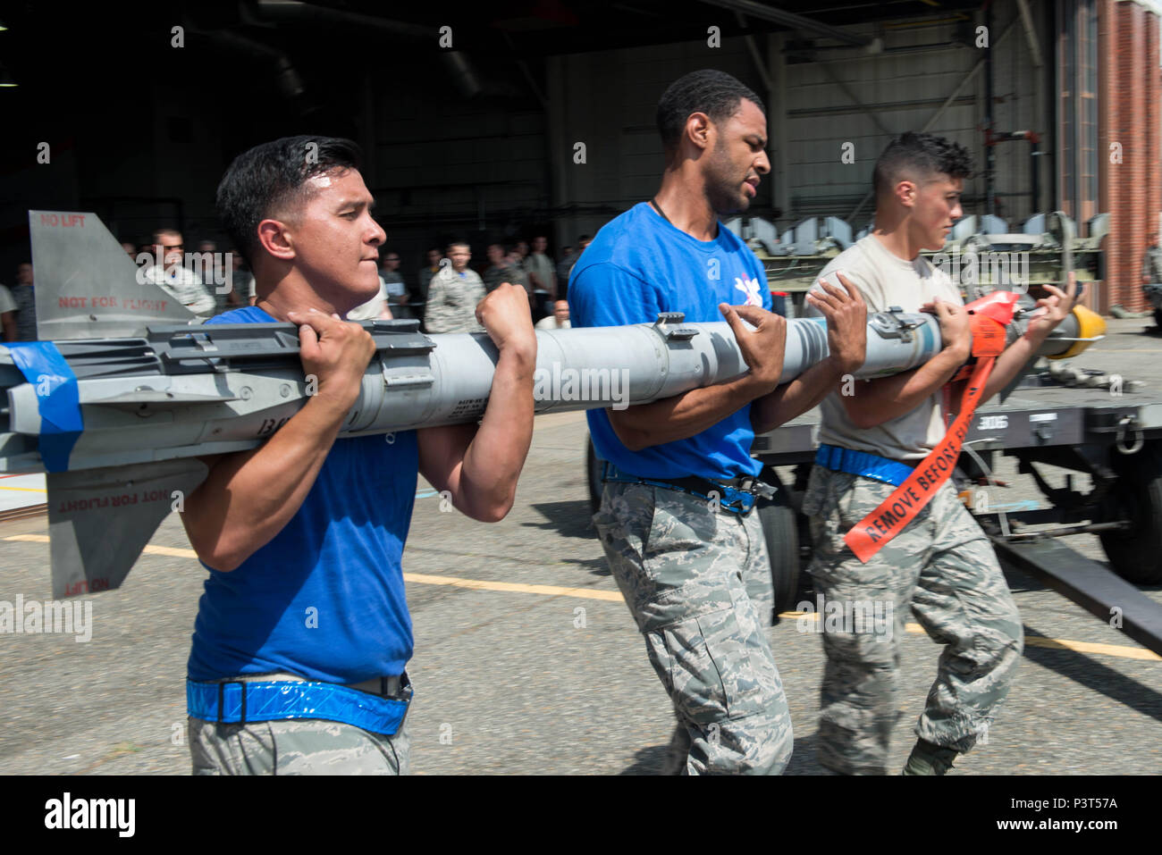 U.S. Air Force Airmen from the 94th Aircraft maintenance unit carry an ...
