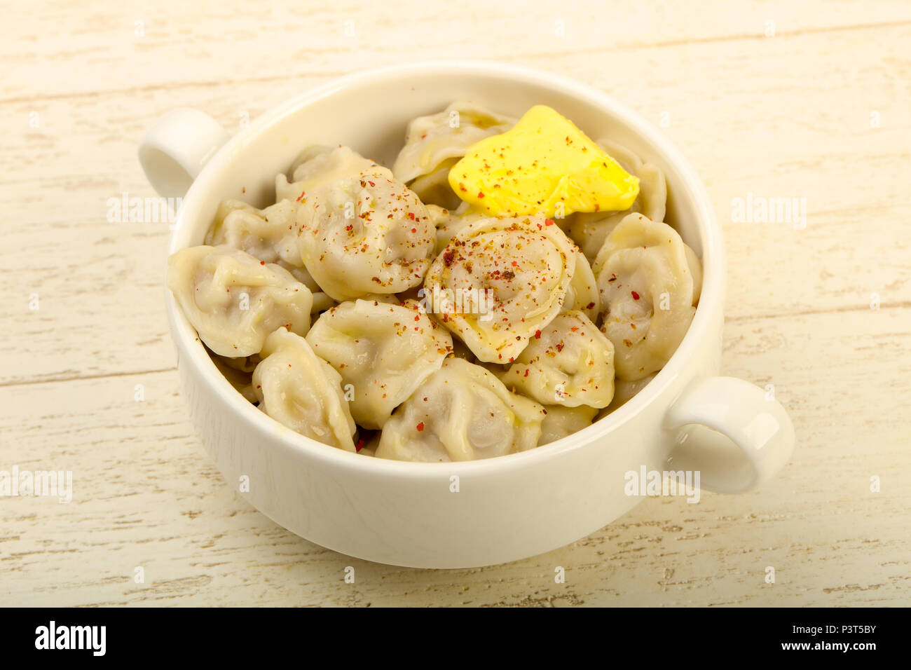 Russian dumplings with butter, pepper and spices Stock Photo - Alamy