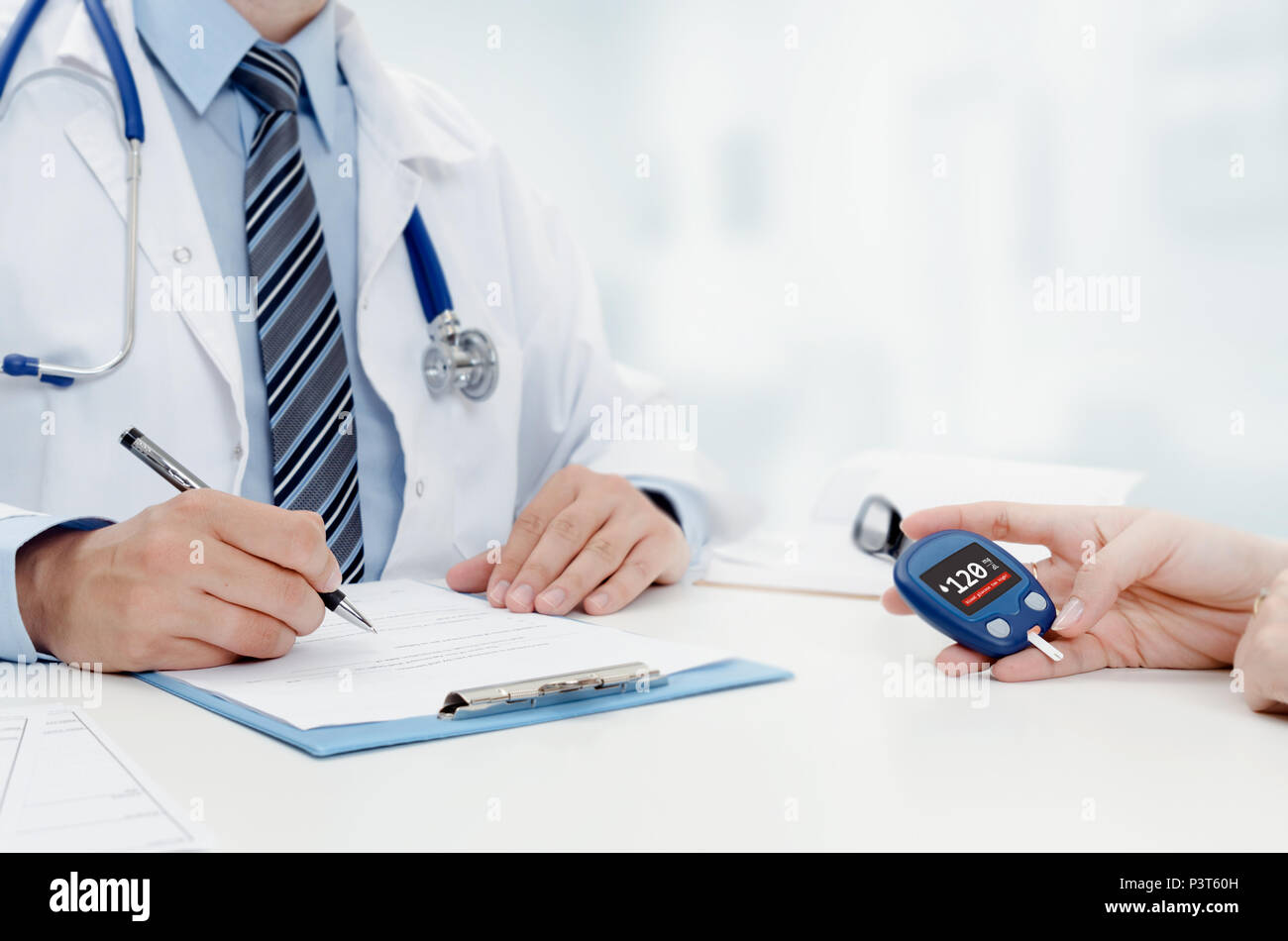 Patient holding glucometer with glucose level. Doctor and patient ...