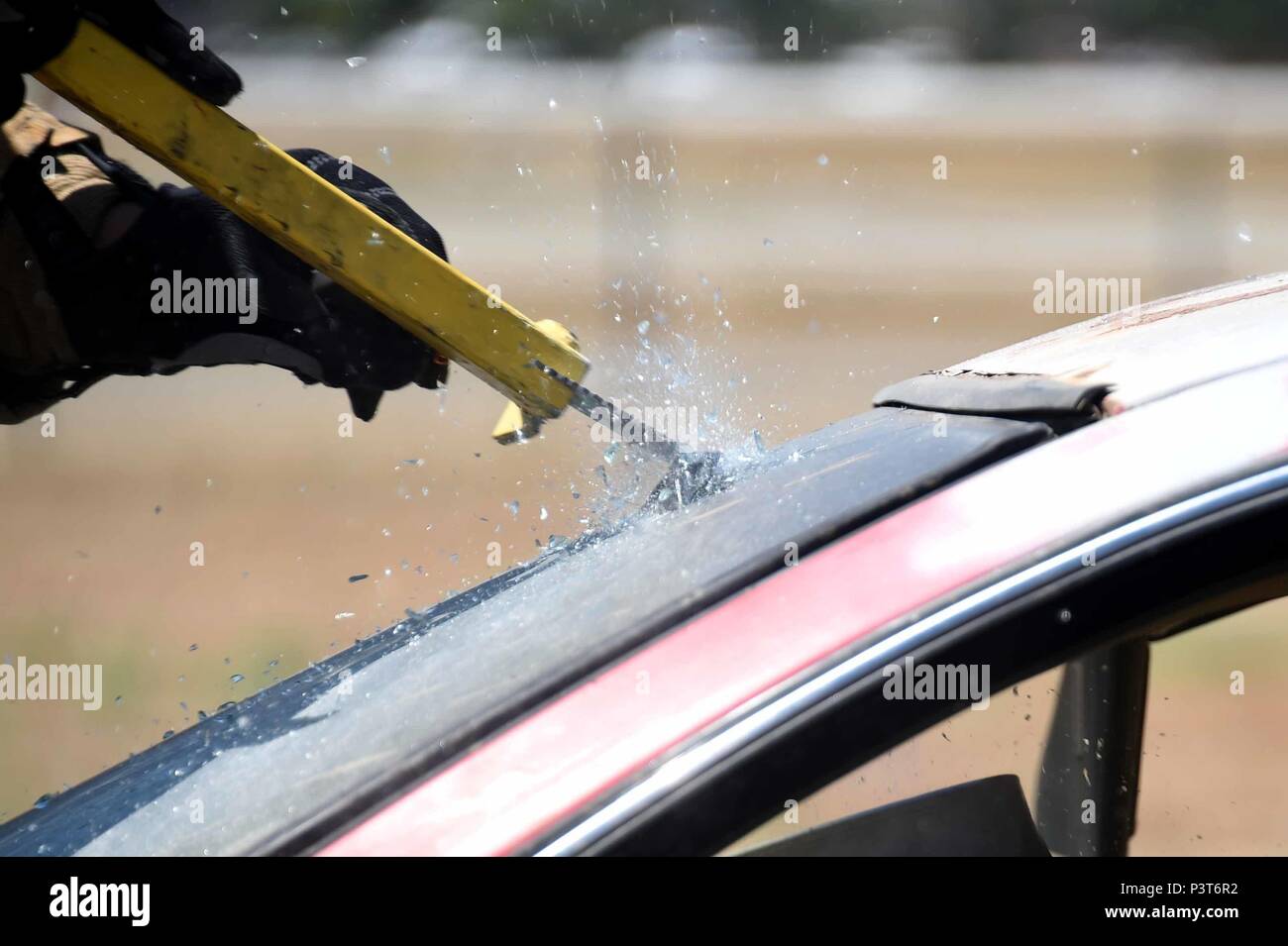A 144th Civil Engineer Squadron firefighter cuts through a windshield ...