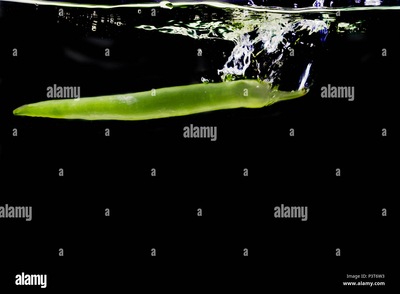 Vegetables fall into the water. Splash of water Stock Photo - Alamy