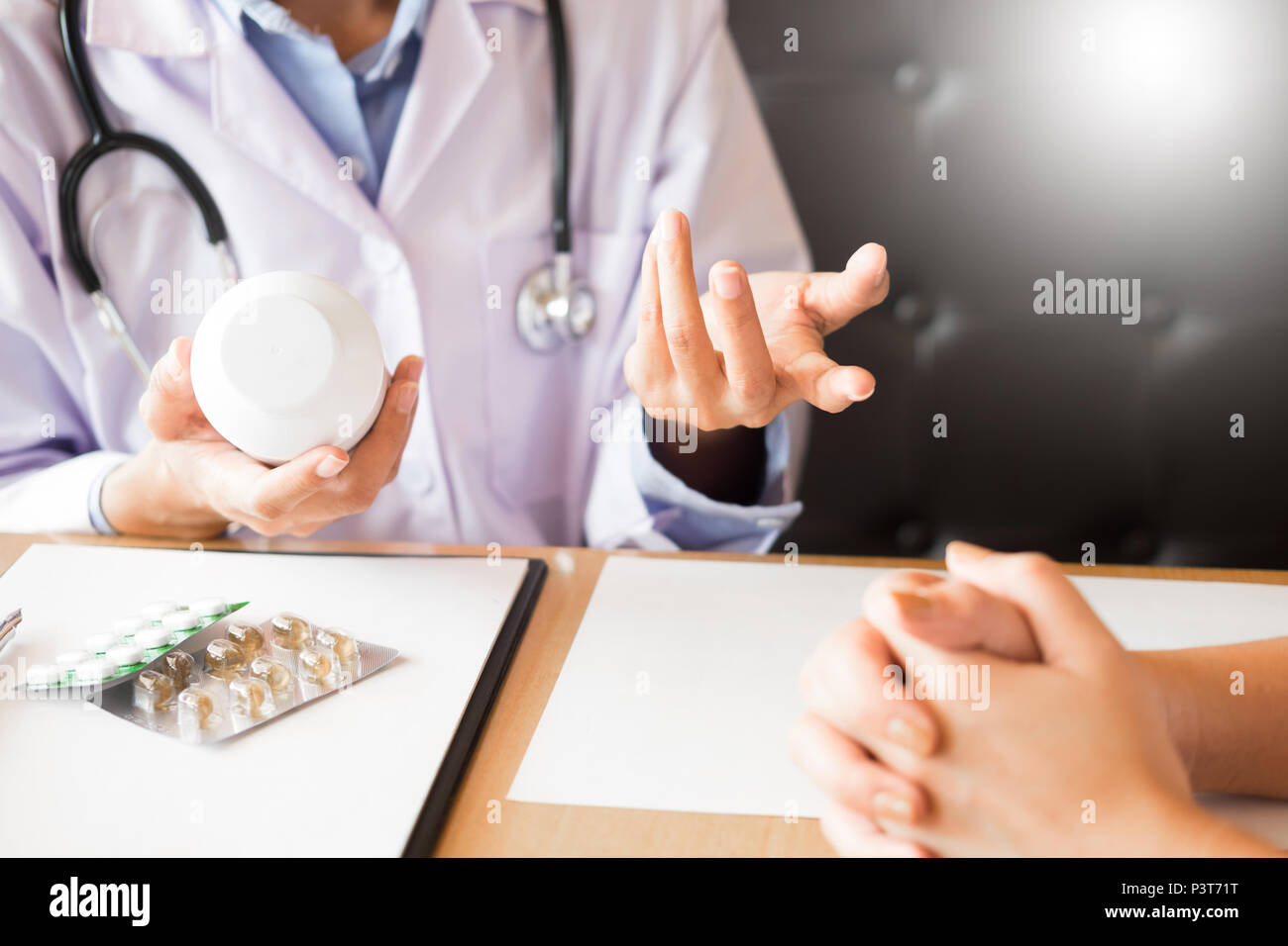 doctor hand holding tablet of drug and explain to patient in hospital ...