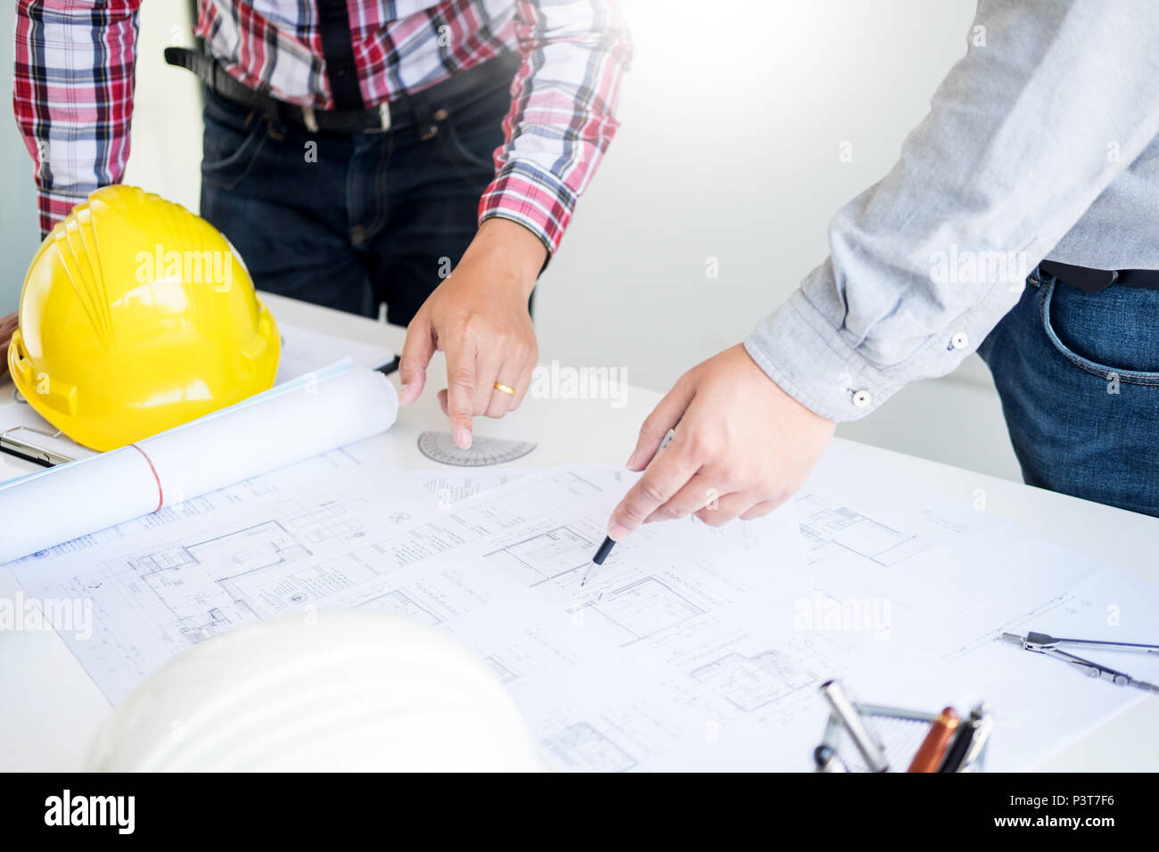 Close-up Of Person's engineer Hand Drawing Plan On Blue Print with ...