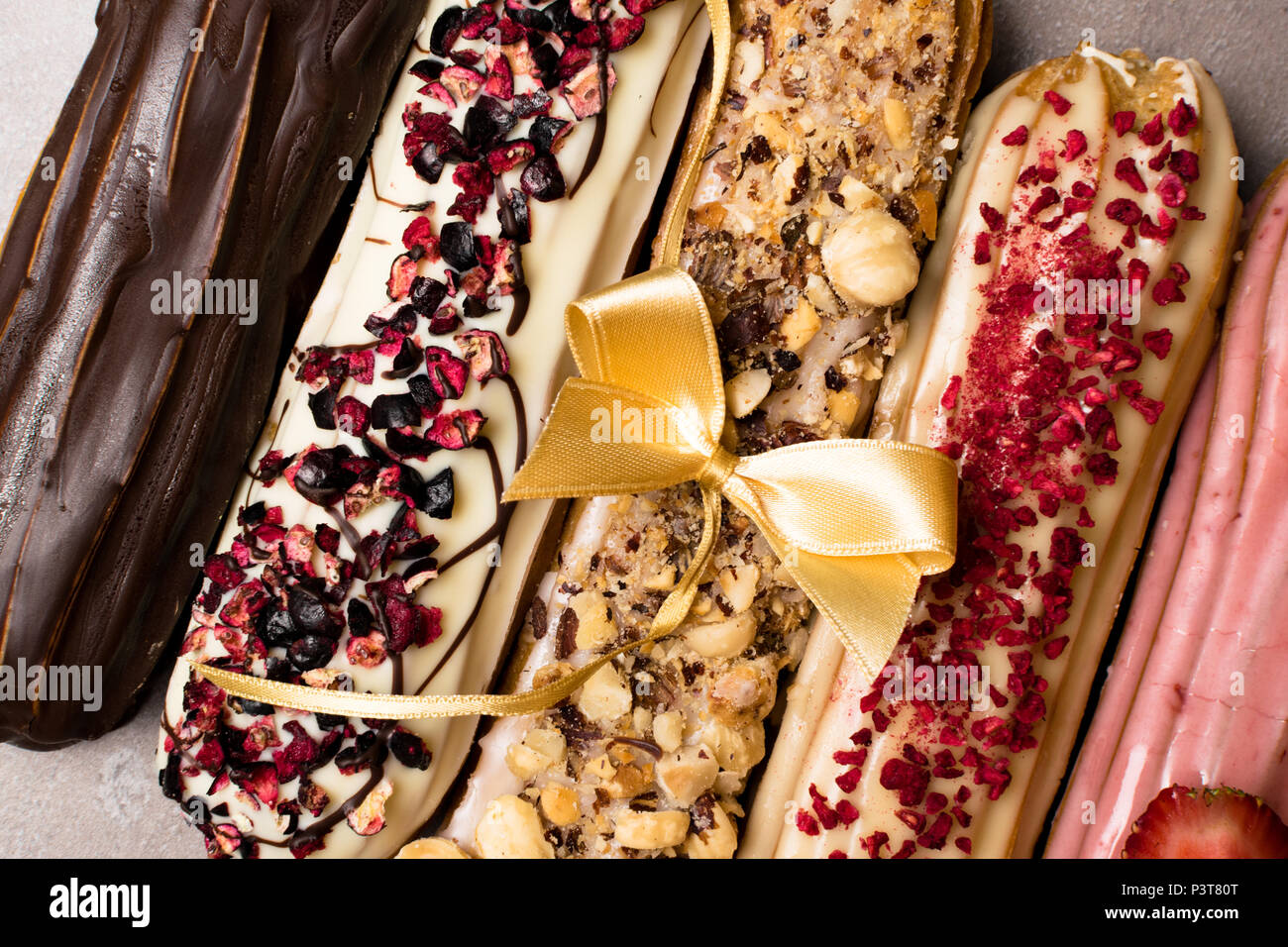 Sweet delicious colorful french eclairs. Group of french dessert with ...