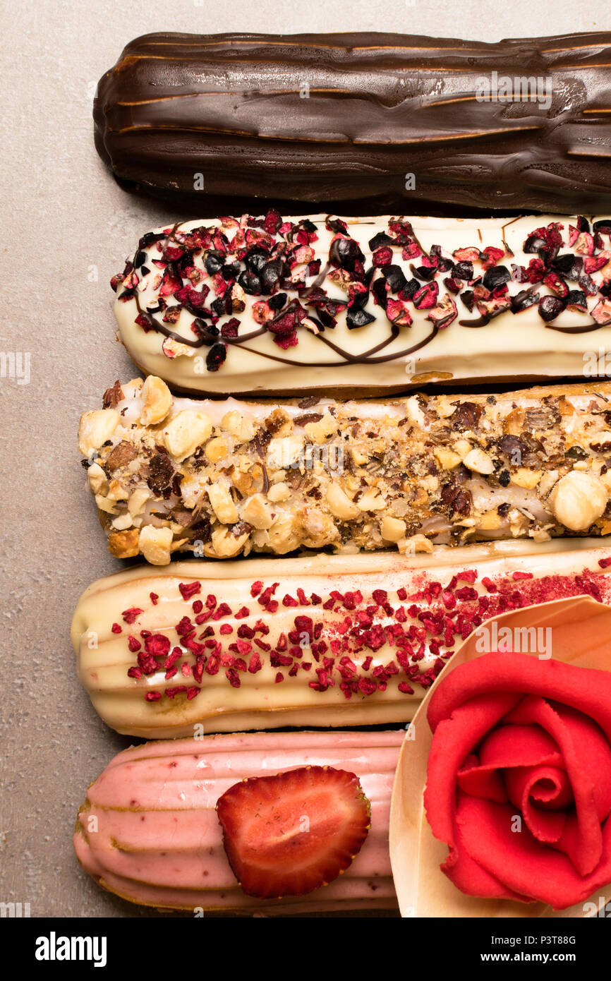 Sweet delicious colorful french eclairs decorated with marzipan red ...