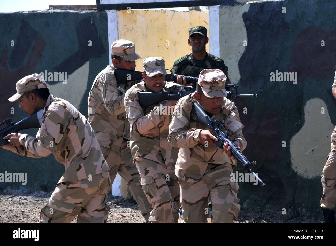 A team of Iraqi army ranger students conducts a glass house room ...