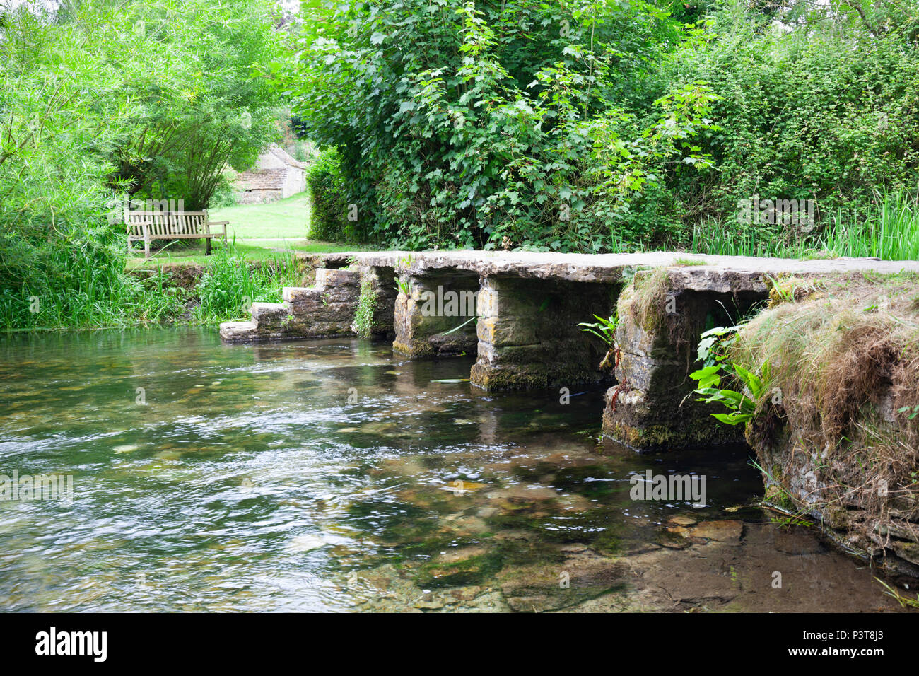 Stone footbridge over the River Leach, Eastleach, The Cotswolds ...