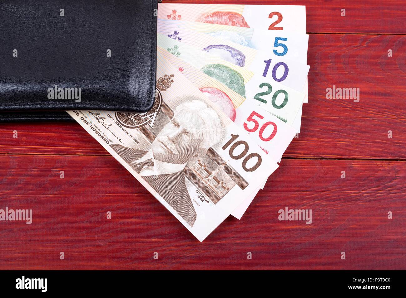 Canadian money in the black wallet Stock Photo - Alamy