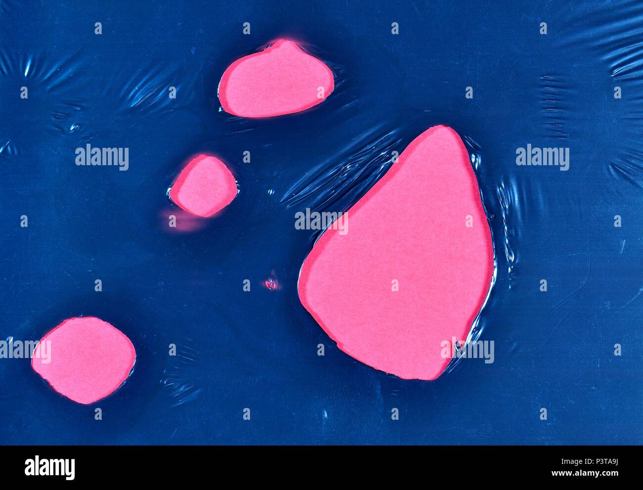 Scratched blue plastic texture background. With holes caused by flames ...