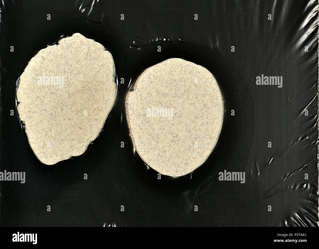 Scratched black plastic texture background. With holes caused by flames ...