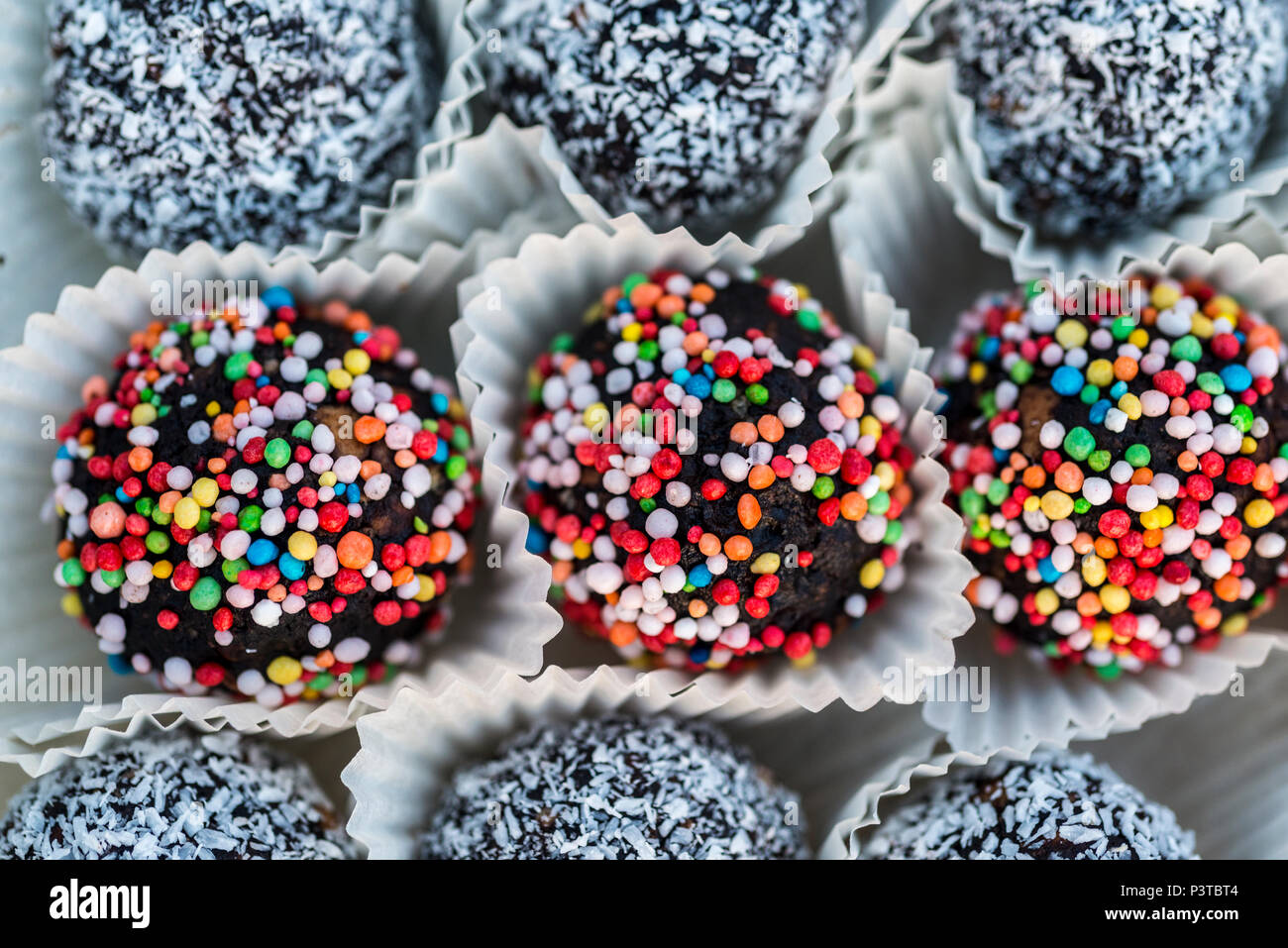 Chocolate ball with coconut and colorful topping Stock Photo - Alamy