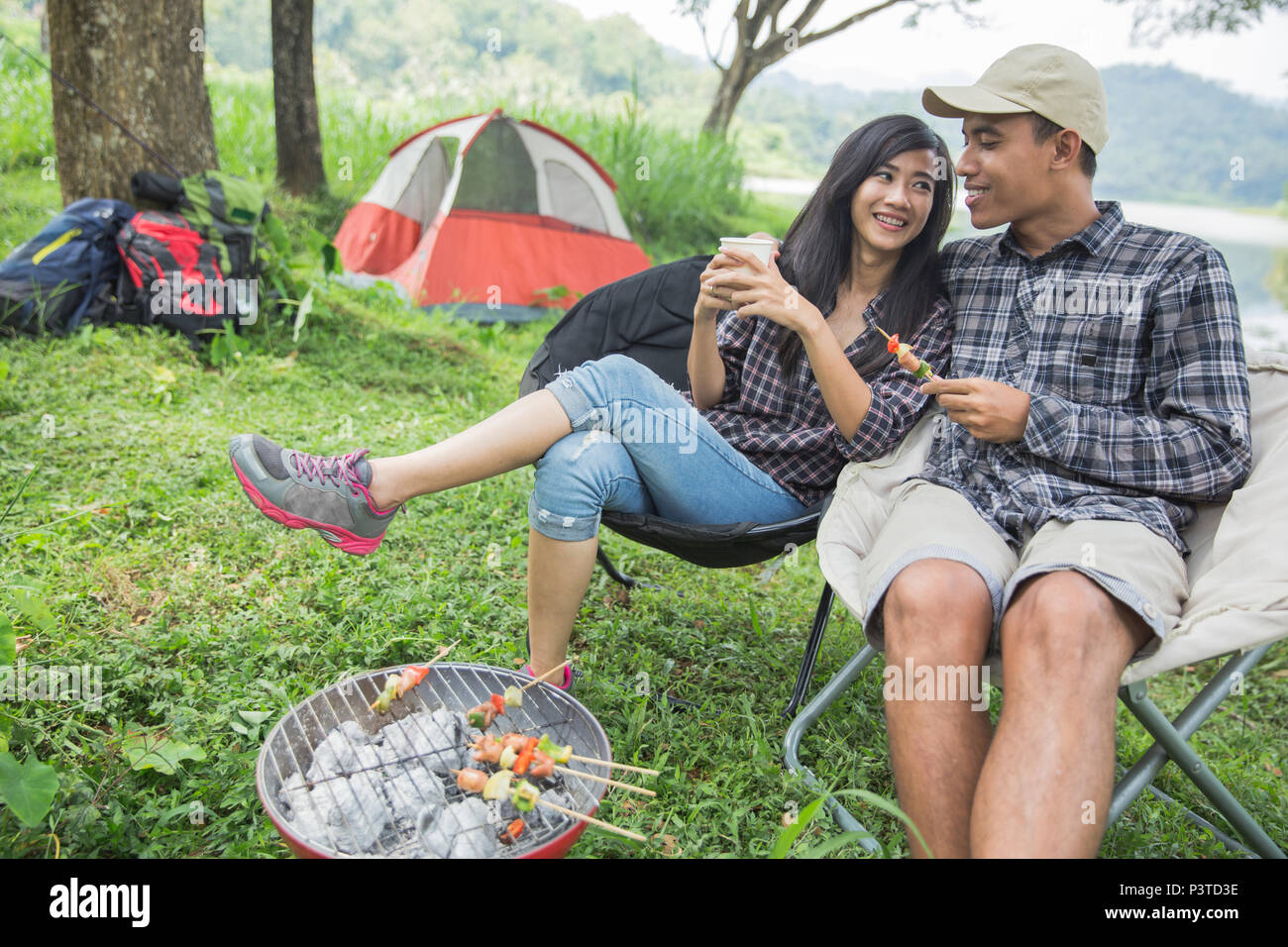 two asian couple in nature camping Stock Photo - Alamy