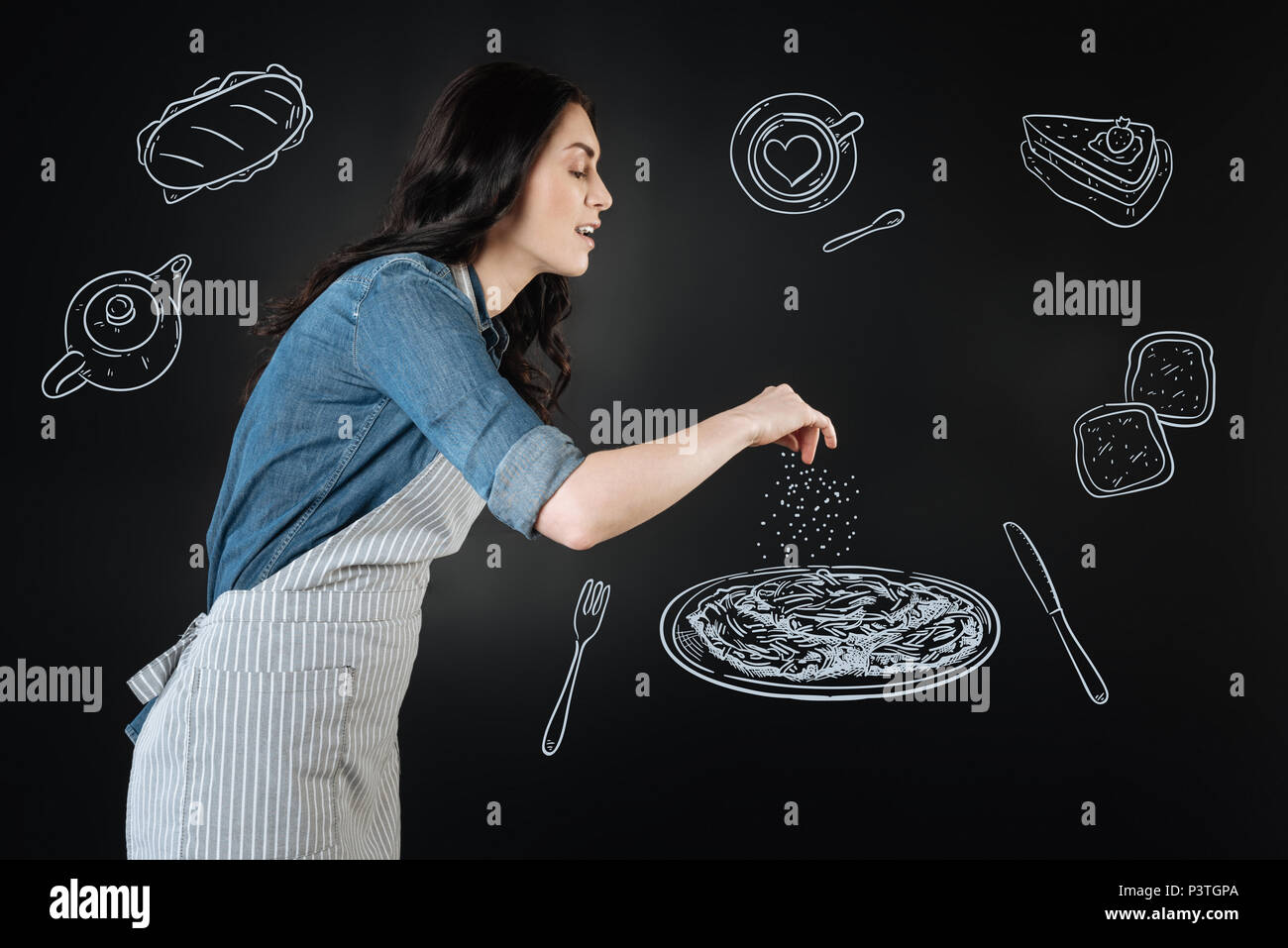 Careful chef adding spices while cooking pasta Stock Photo - Alamy