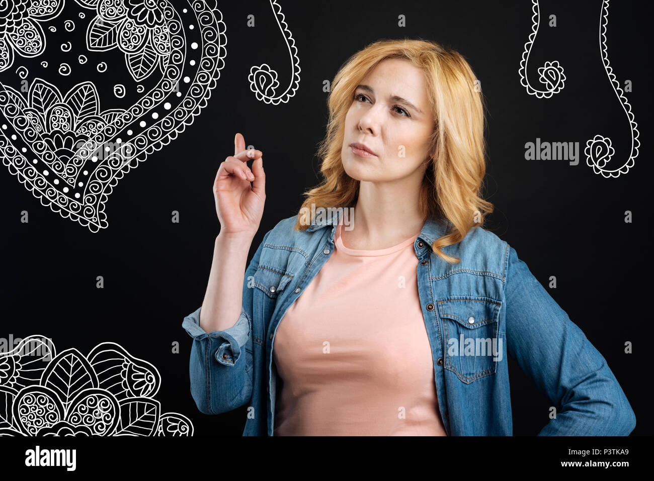 Calm designer looking at the pattern and thinking Stock Photo - Alamy