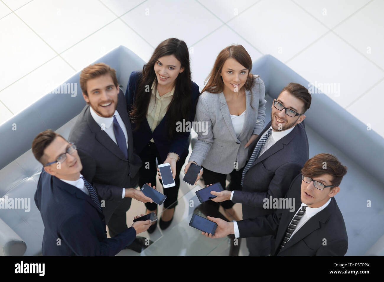 Group of business colleagues using mobile phones in the office Stock ...