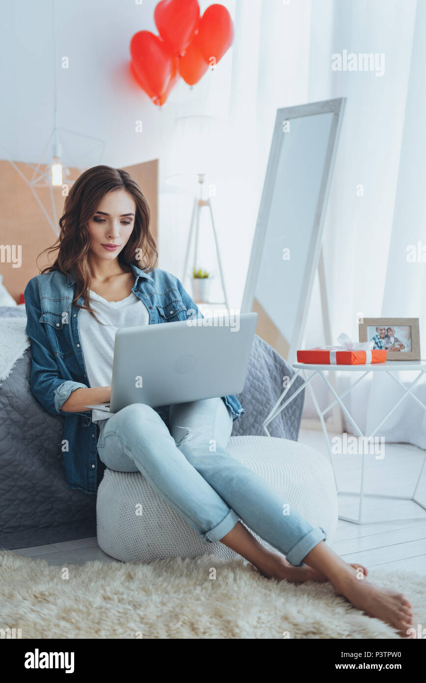 Serious young woman working at home Stock Photo - Alamy