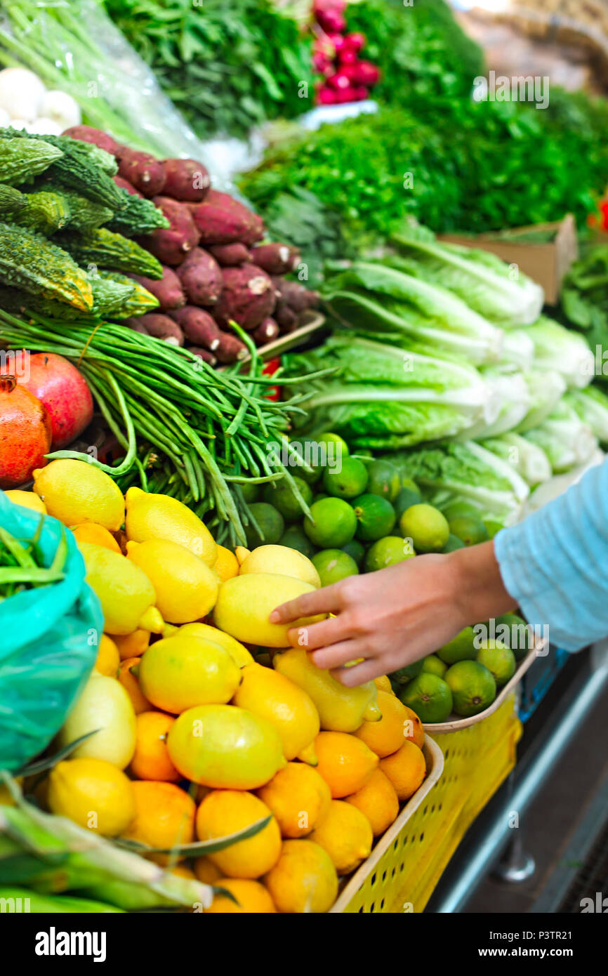 Woman choosing fruit at vegetable open air market Stock Photo - Alamy