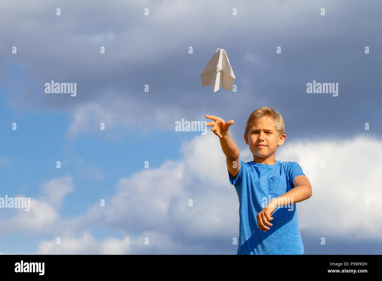 Child throwing paper plane hi-res stock photography and images - Alamy