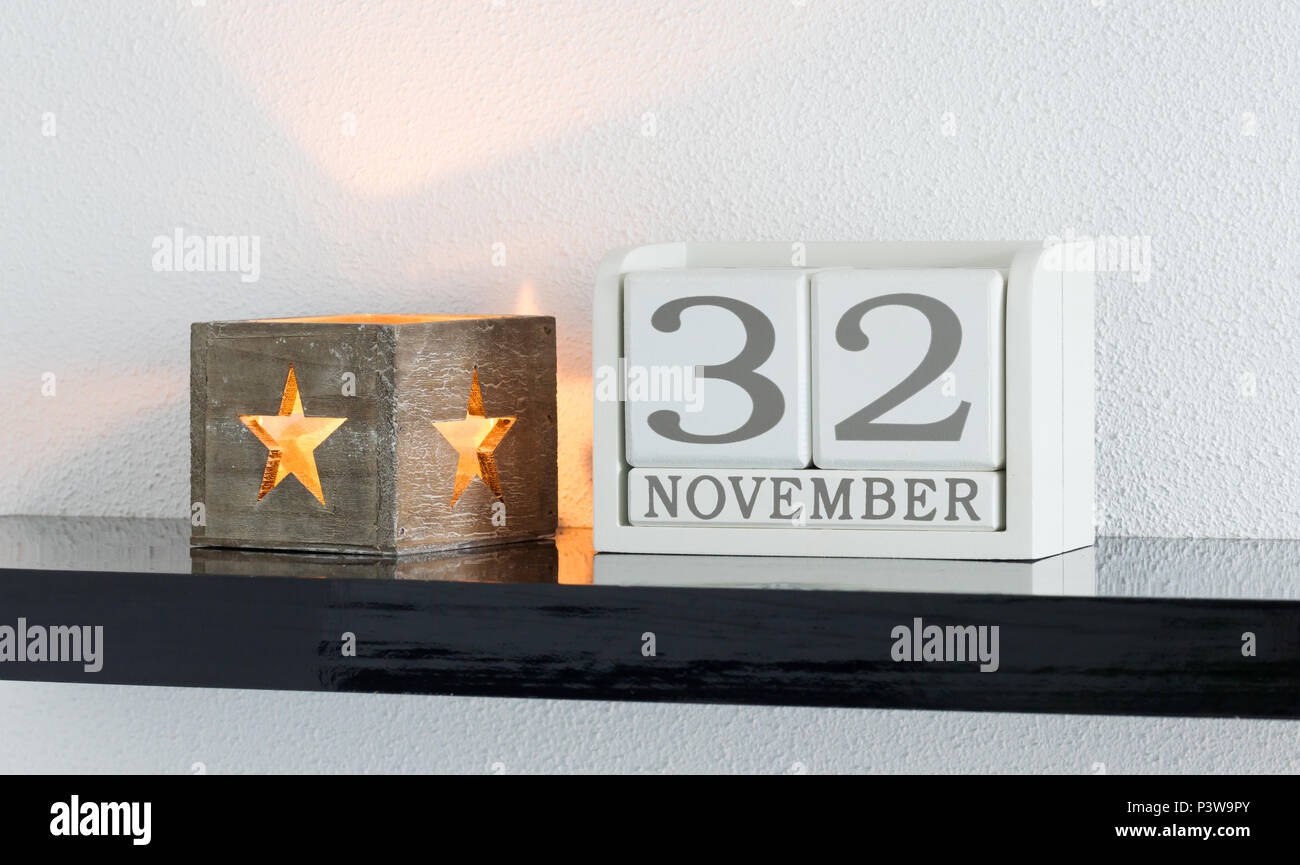 White block calendar present date 32 and month November on white wall ...