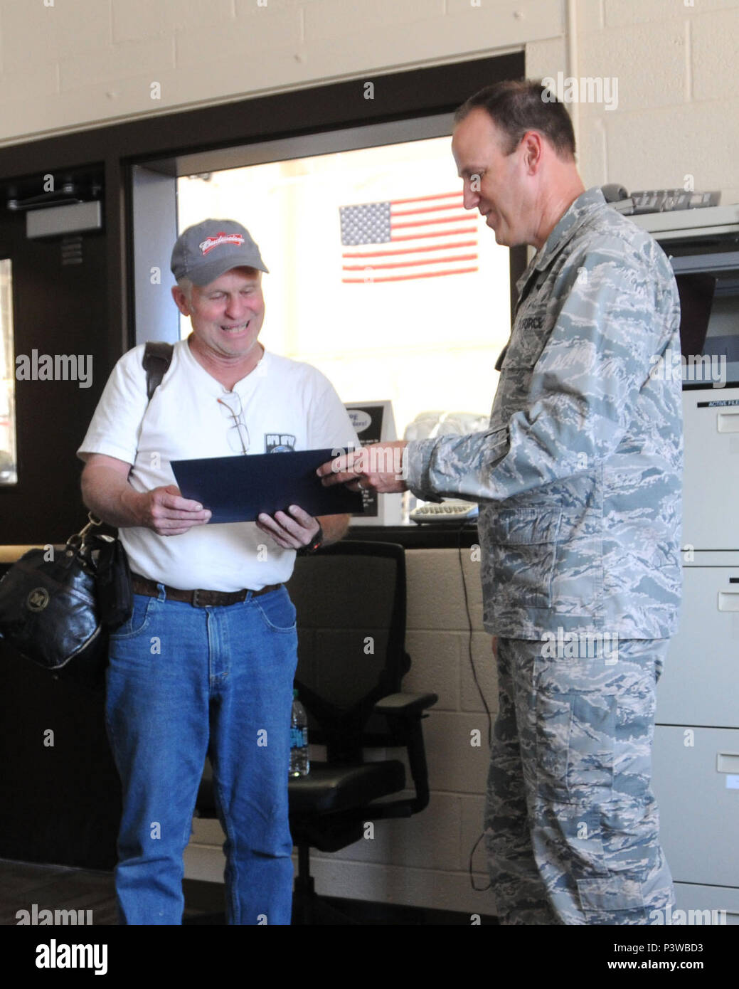 Col. Lee Smith, commander of the 120th Airlift Wing, presents a ...