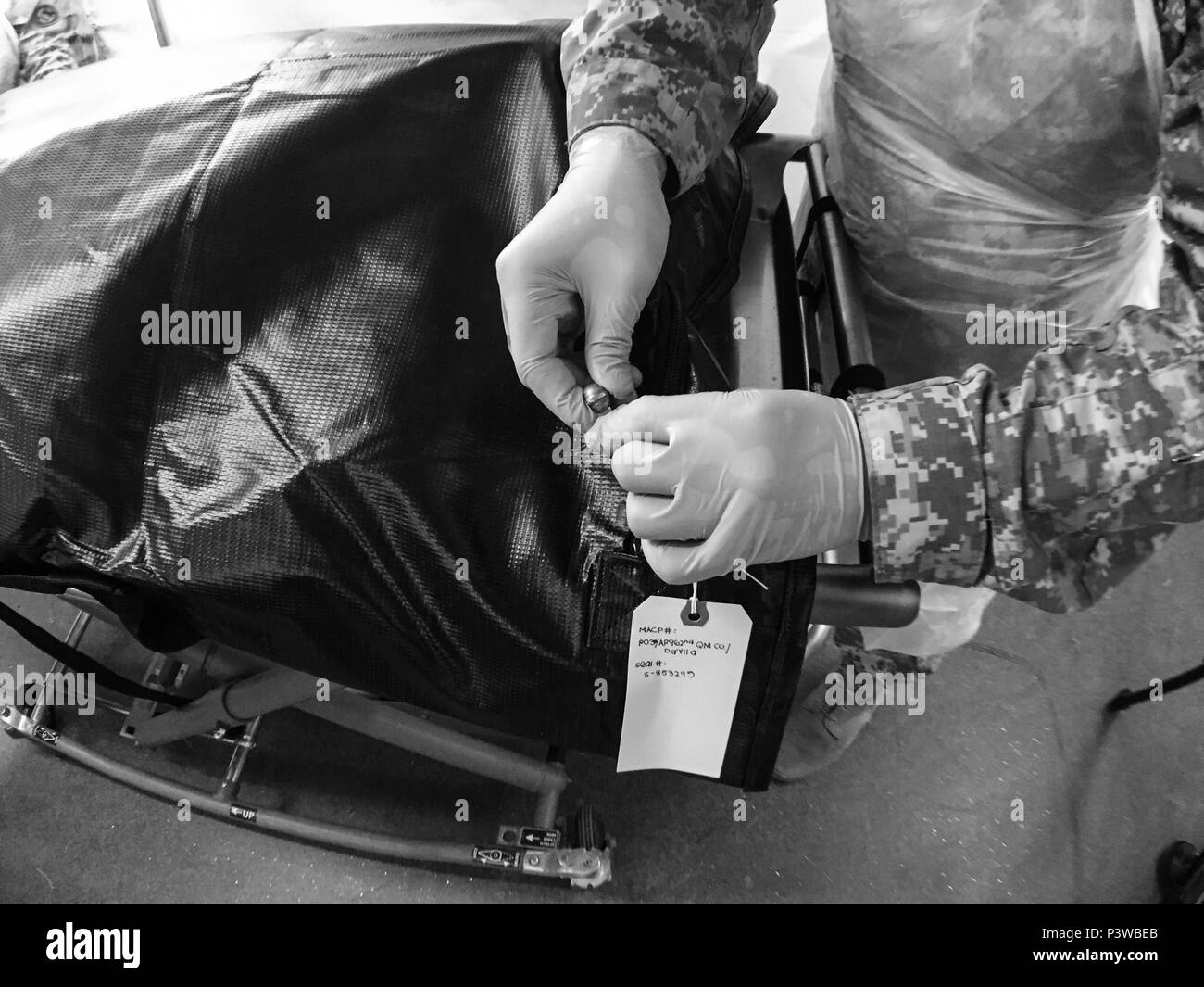 Simulated human remains are sealed in a Human Remains Pouch at a ...