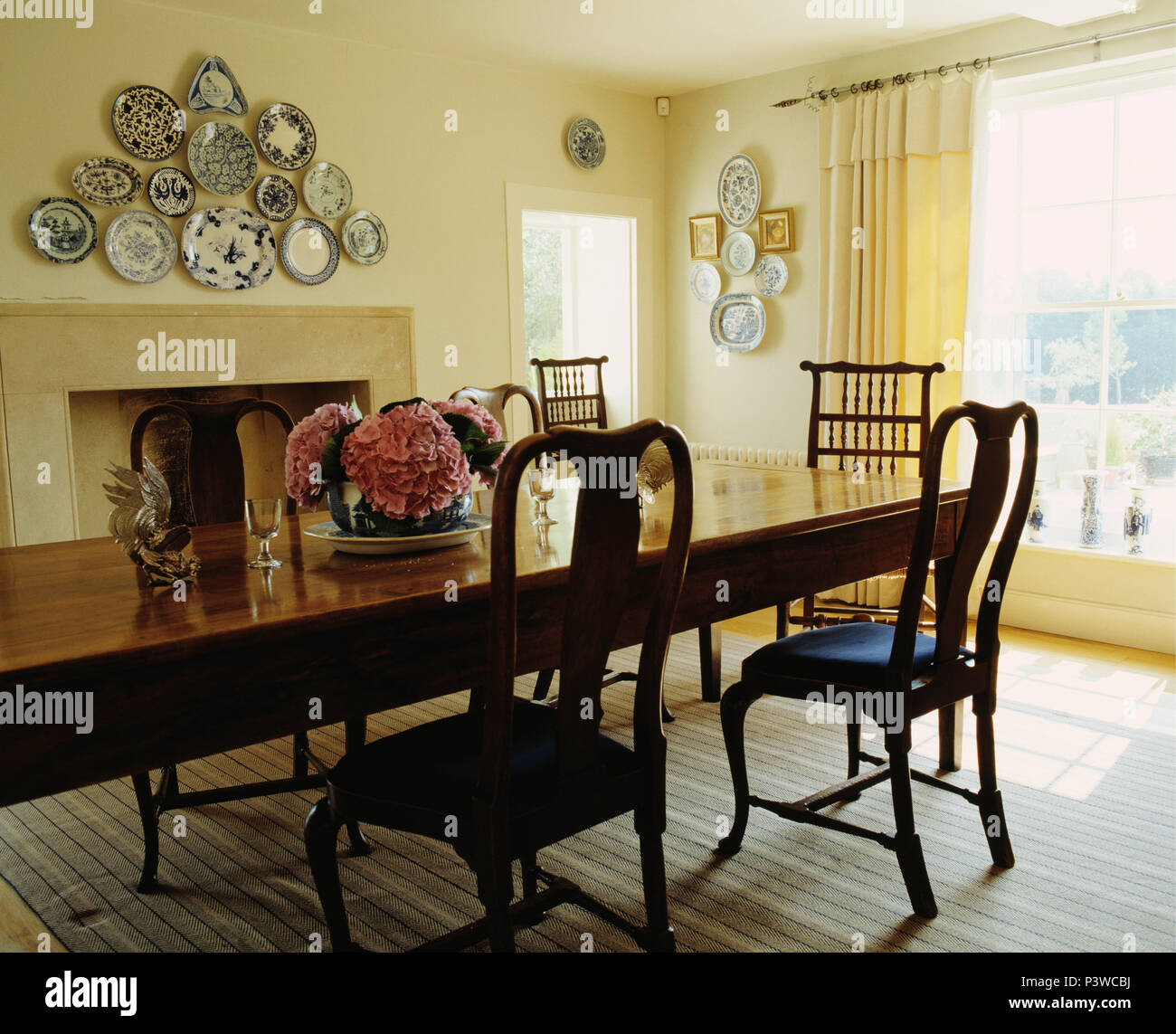 blue+white plates in triangular formation above fireplace in dining ...