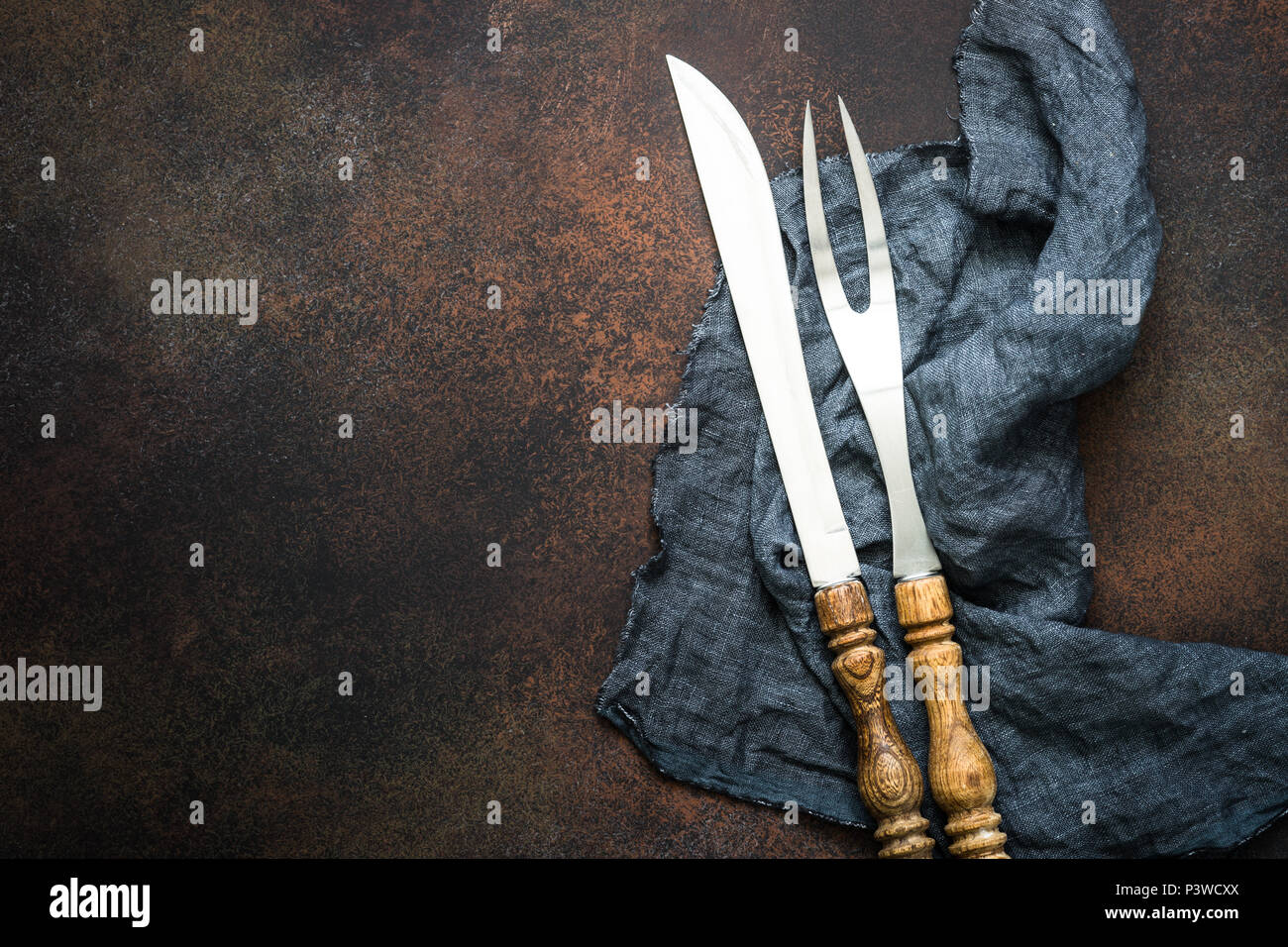 Vintage kitchen utensils - knife and fork on rusty stone table. Top ...