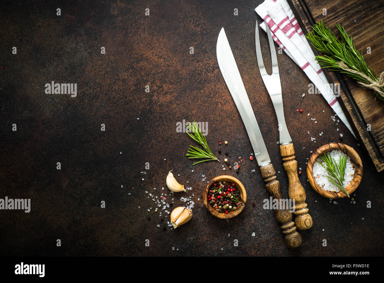Food background. Fork, knife, cutting board, spices and seasoning on ...