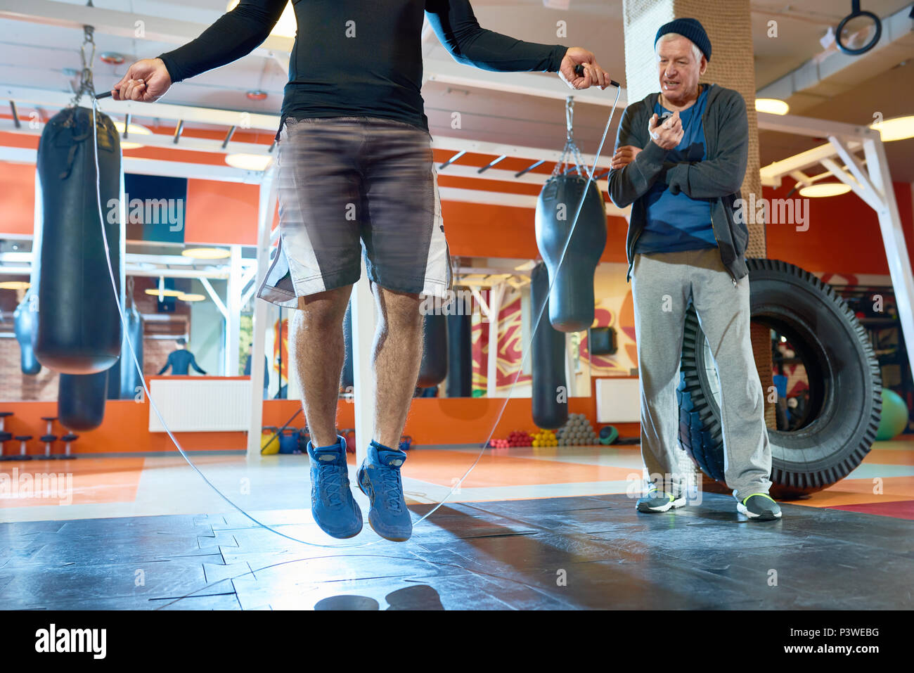 Coach training boxer in gym Stock Photo - Alamy