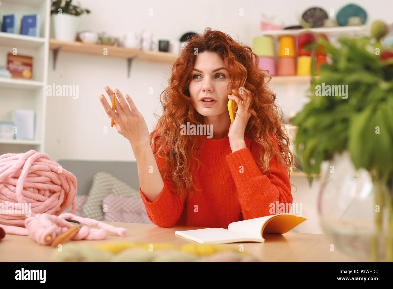 Green-eyed woman having phone dispute with her colleague Stock Photo ...