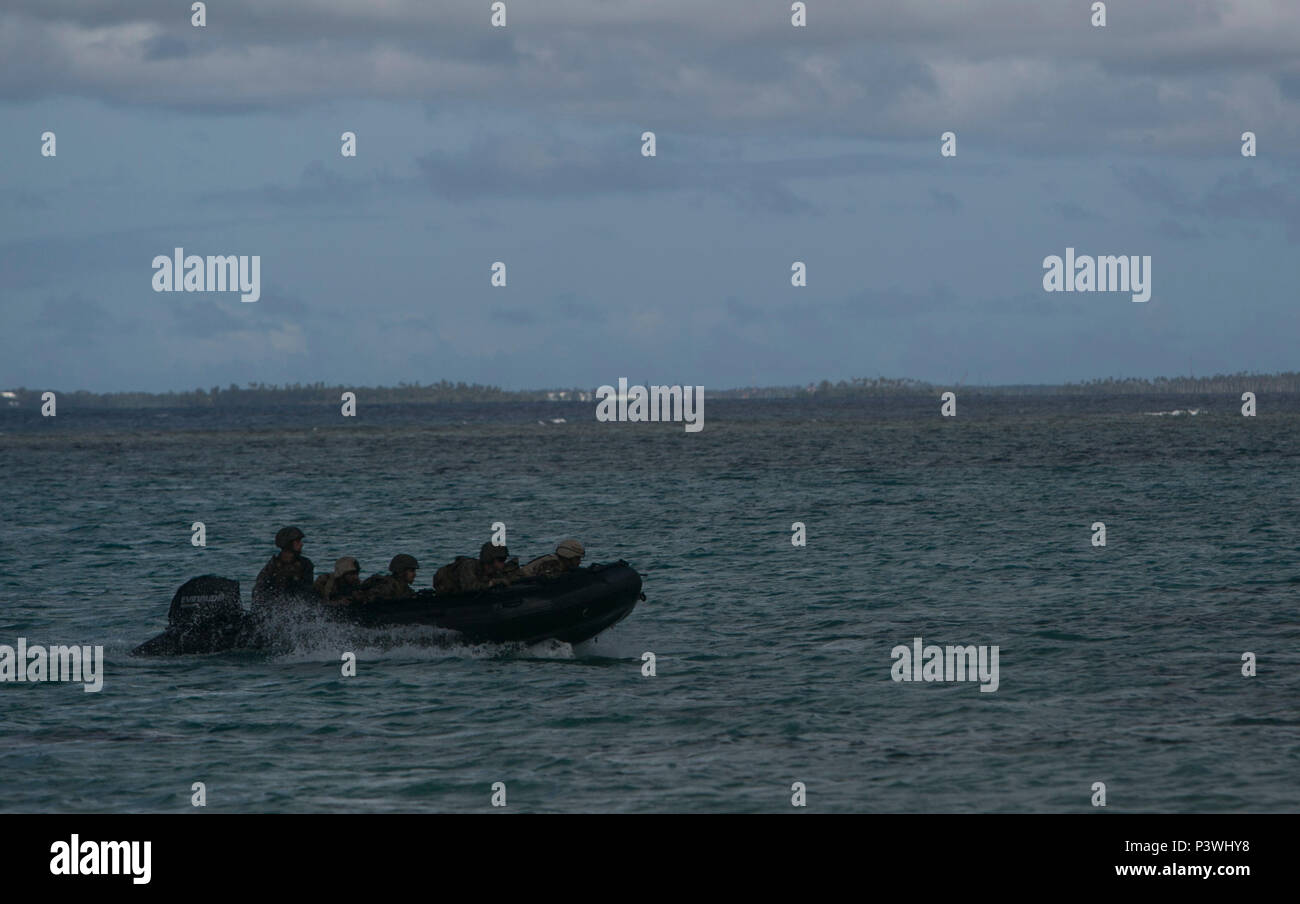 U.S. Marines and Tongan Soldiers maintain a low silhouette on a combat ...