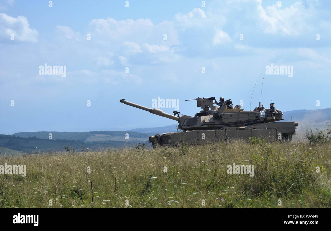 United States Army M1A1 Abrams Tanks maneuver across tank training ...