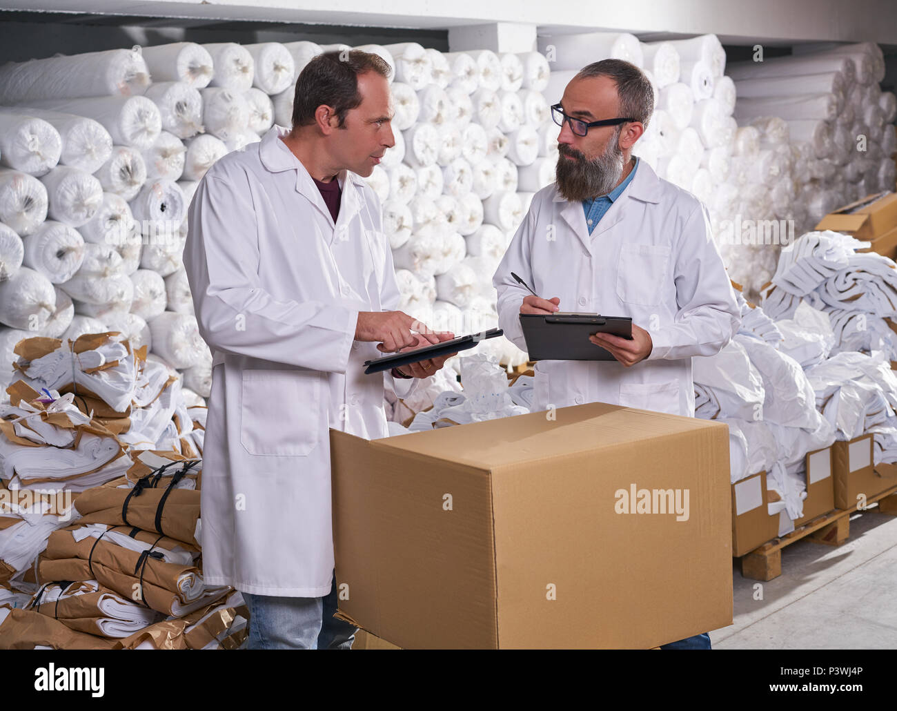 warehouse supervisor and manager men in fashion textile factory Stock ...