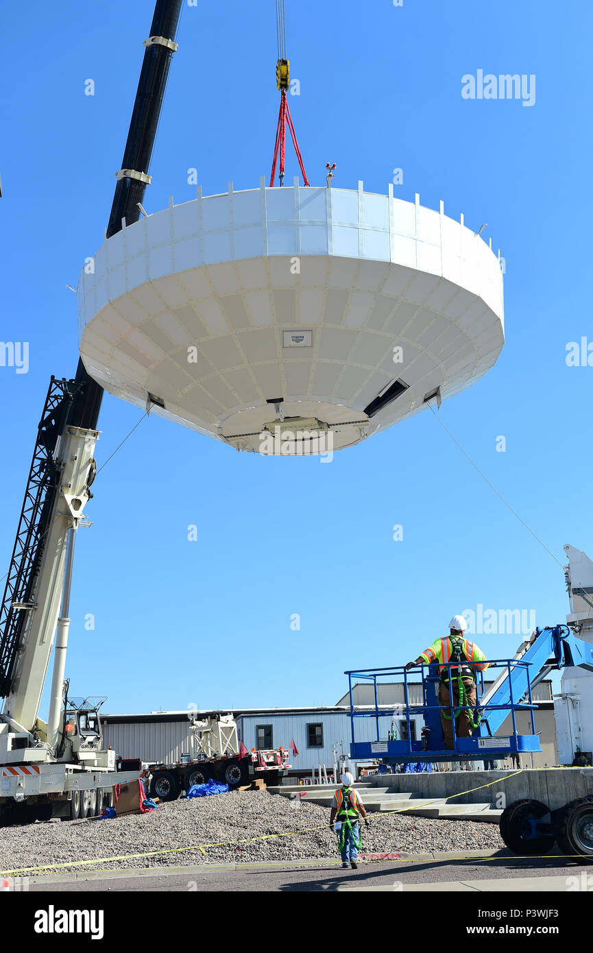 A construction crew works on a radome as part of a multi-step project ...