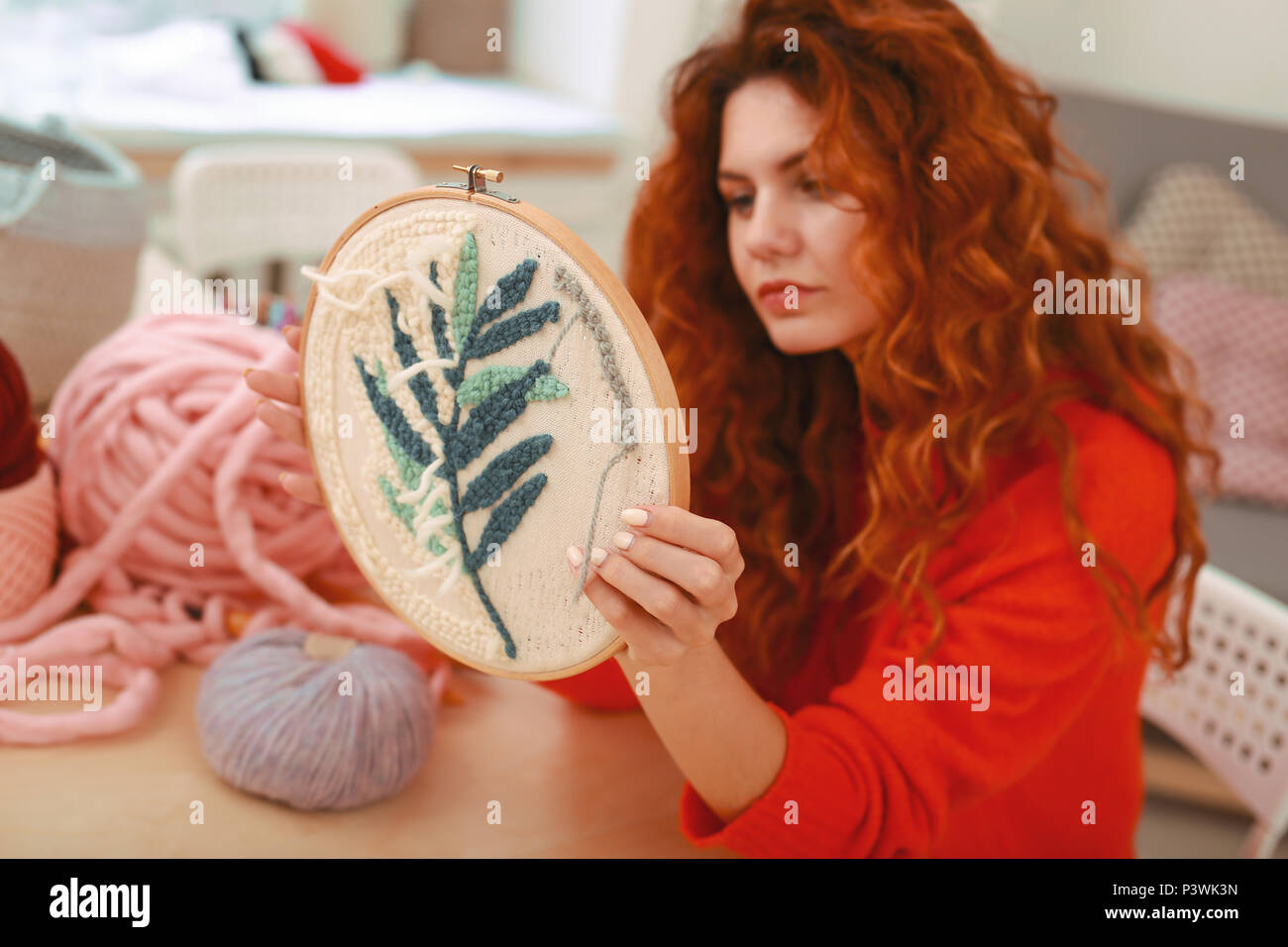 Enthusiastic young girl embroidering little branch Stock Photo - Alamy