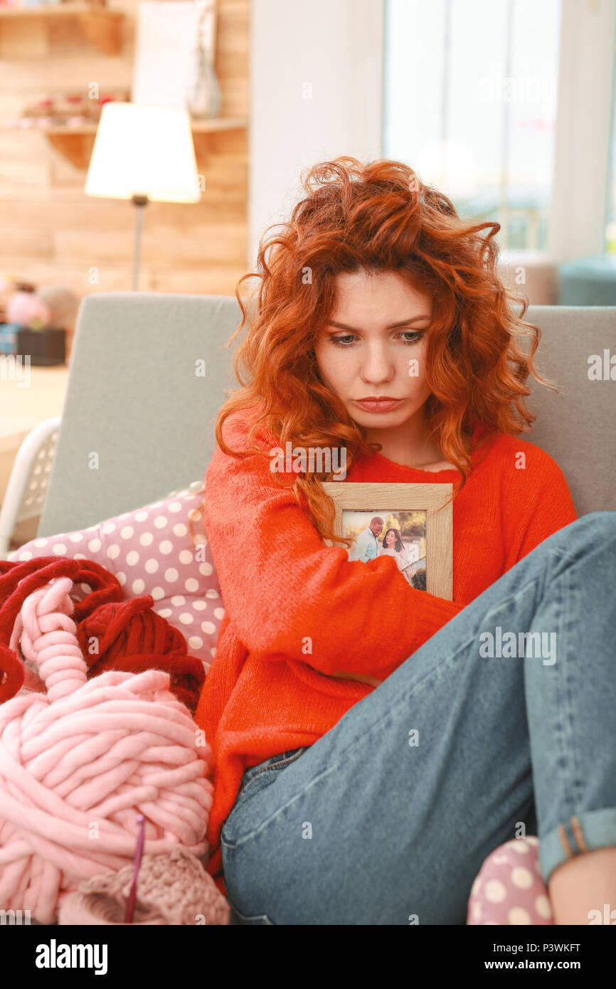 Appealing woman with ginger hair feeling sad Stock Photo - Alamy