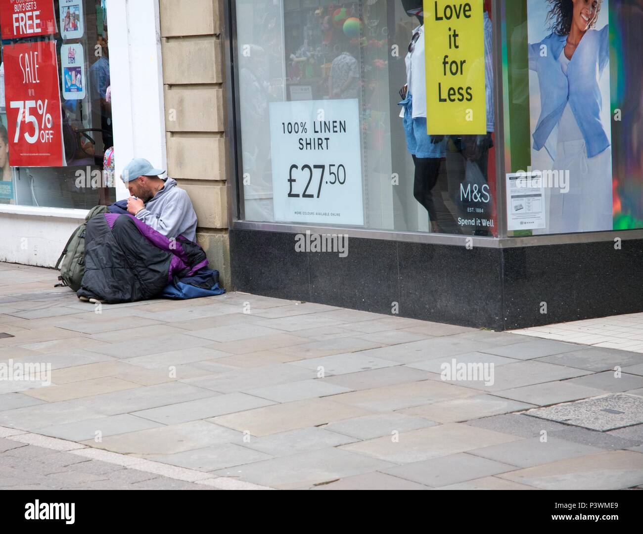 Homeless man outside shop hi-res stock photography and images - Alamy