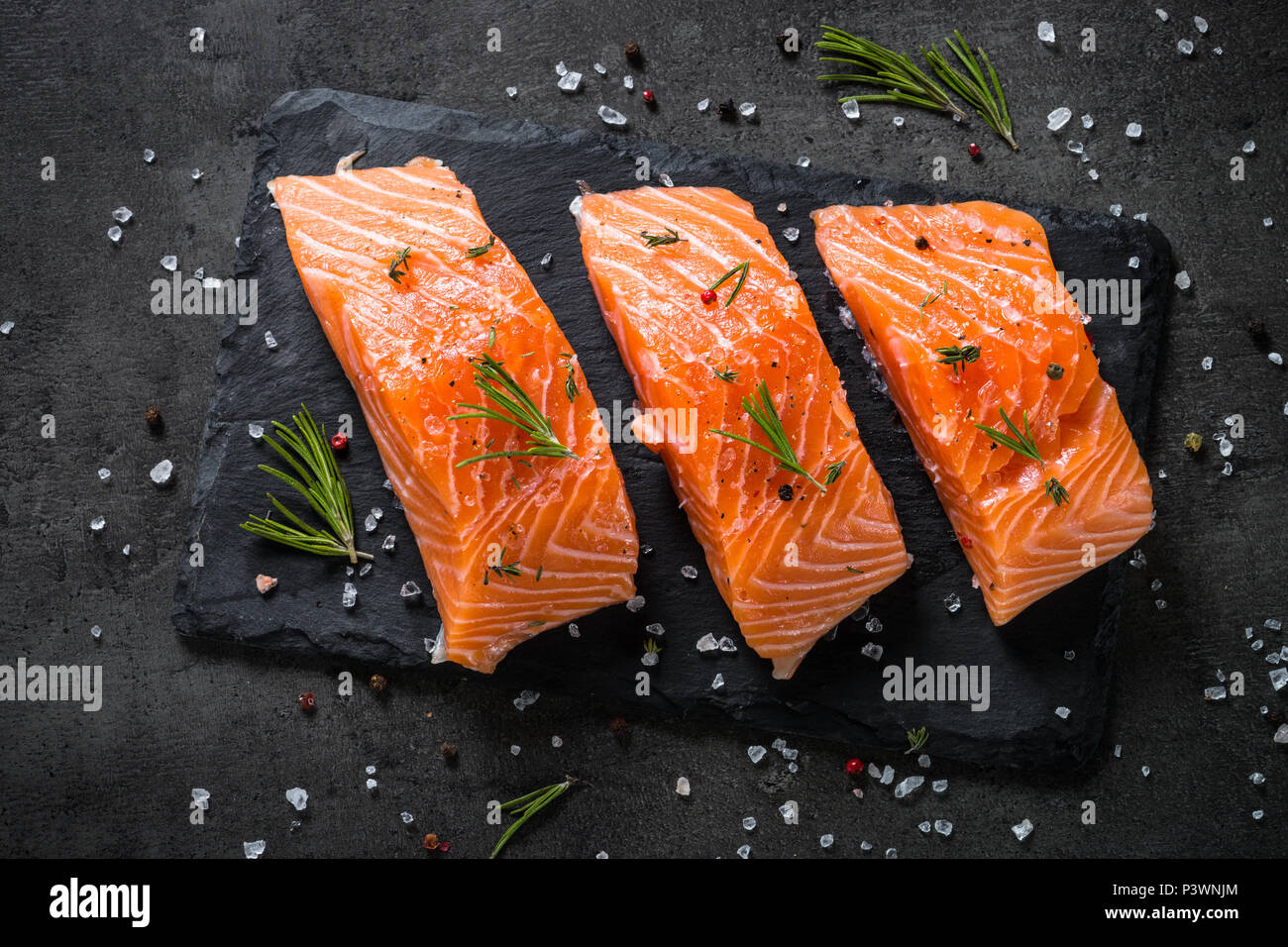 Fresh fish. Salmon uncooked fillet on black slate table. Top view Stock ...
