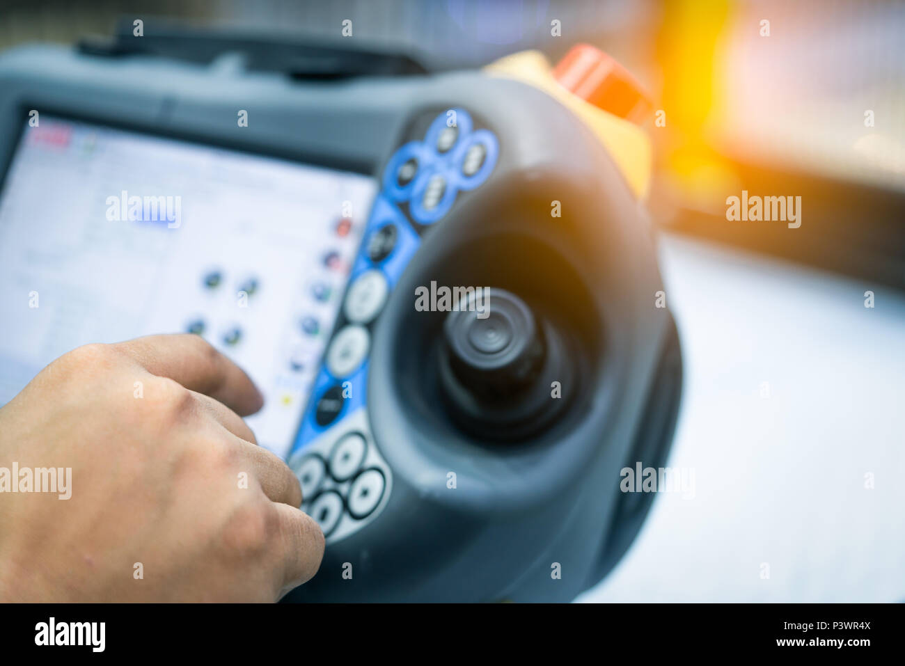 Engineer hand point at control button of robot to control in the ...