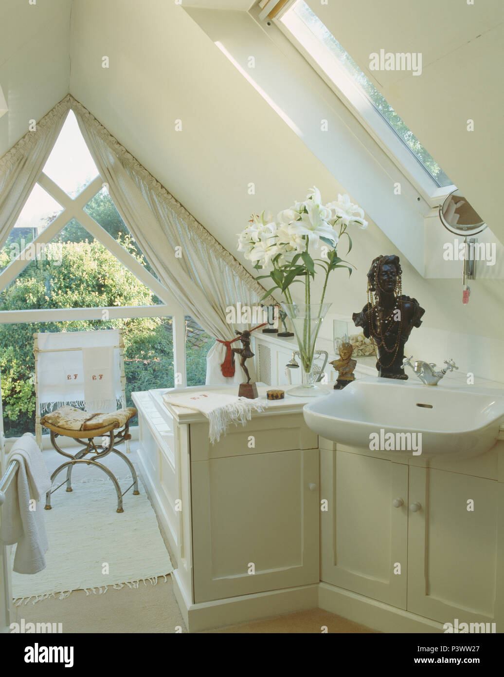 Sculpture beside basin in vanity unit in country loft conversion ...