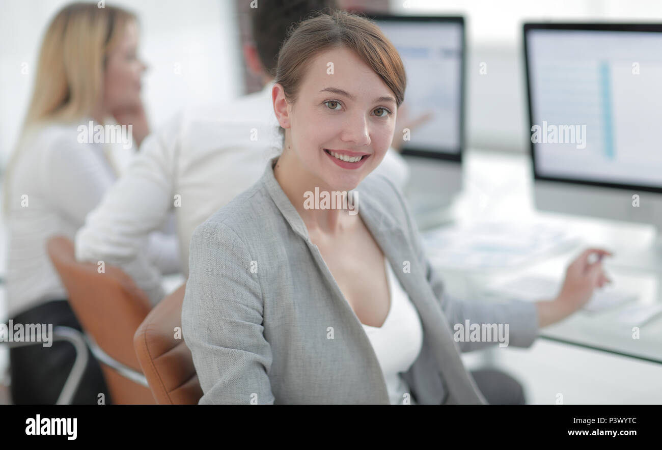 rear view. beautiful business woman sitting near the desktop and ...
