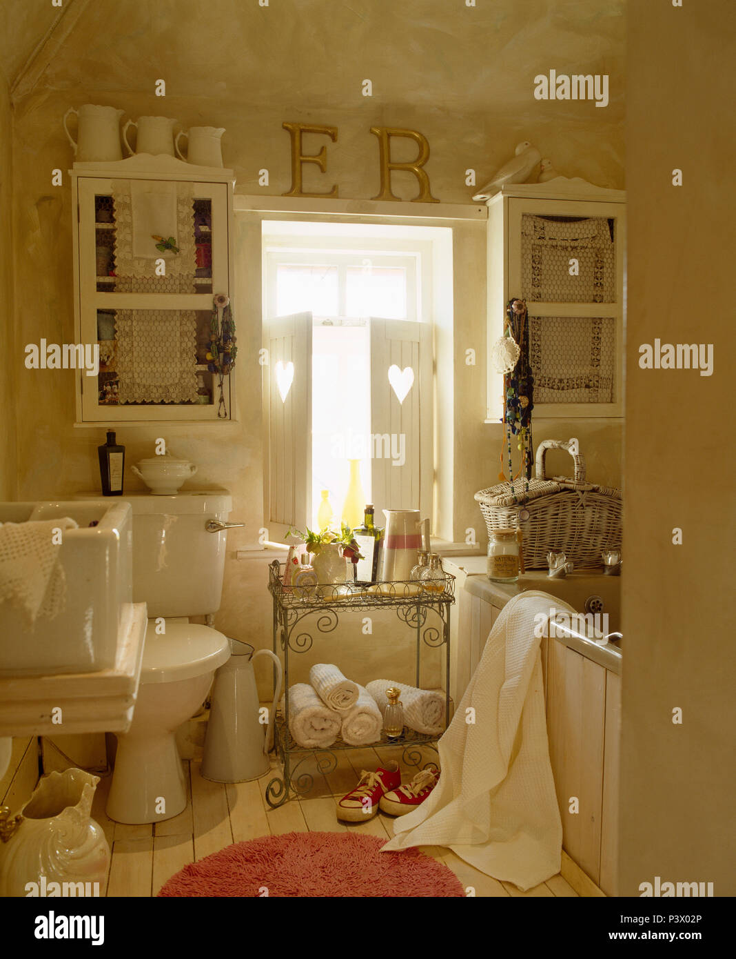 Small glass-front cupboards on either side of window with wooden ...