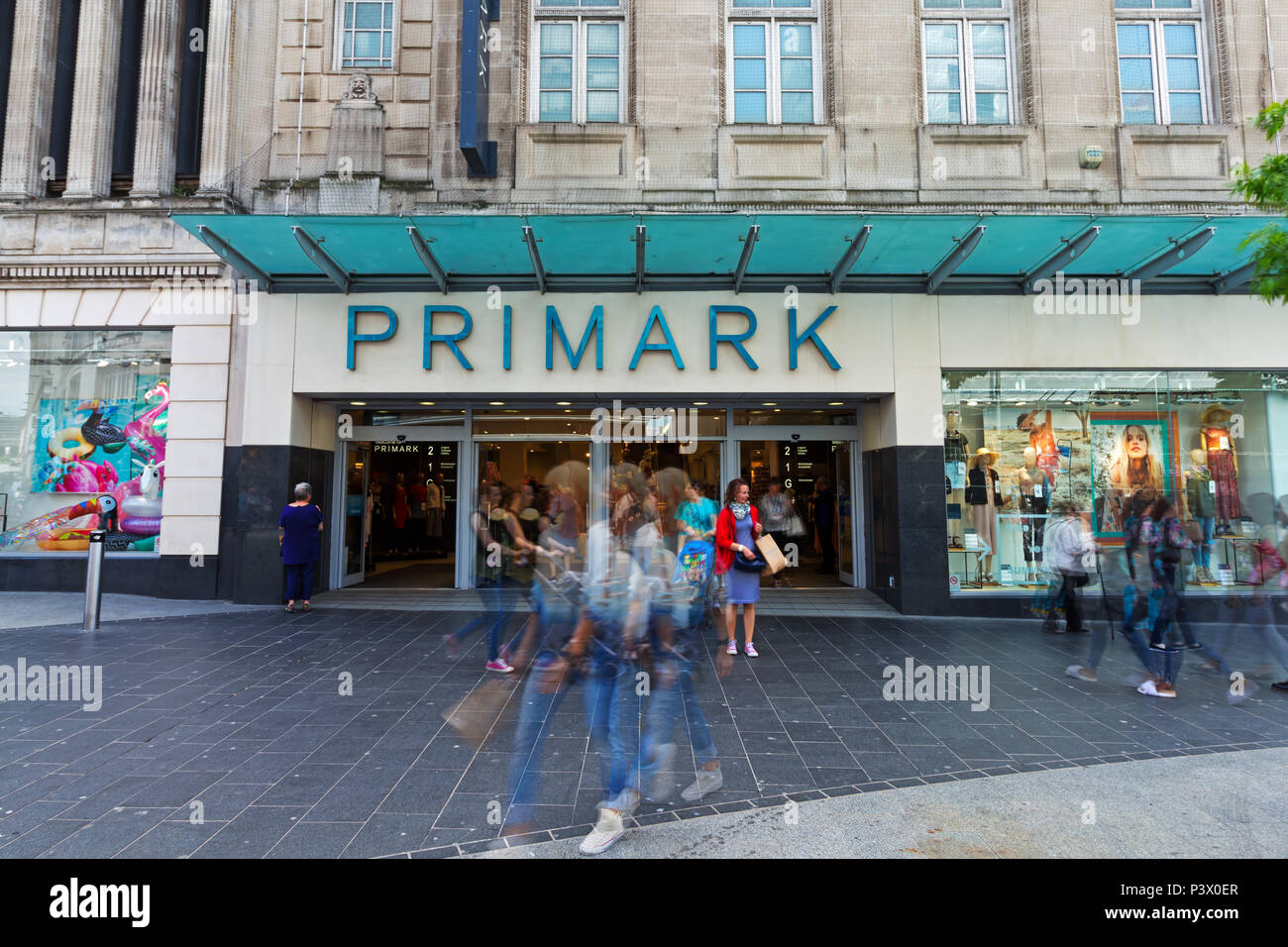 Multiple exposure of shoppers walking past a Primark store on Church St ...