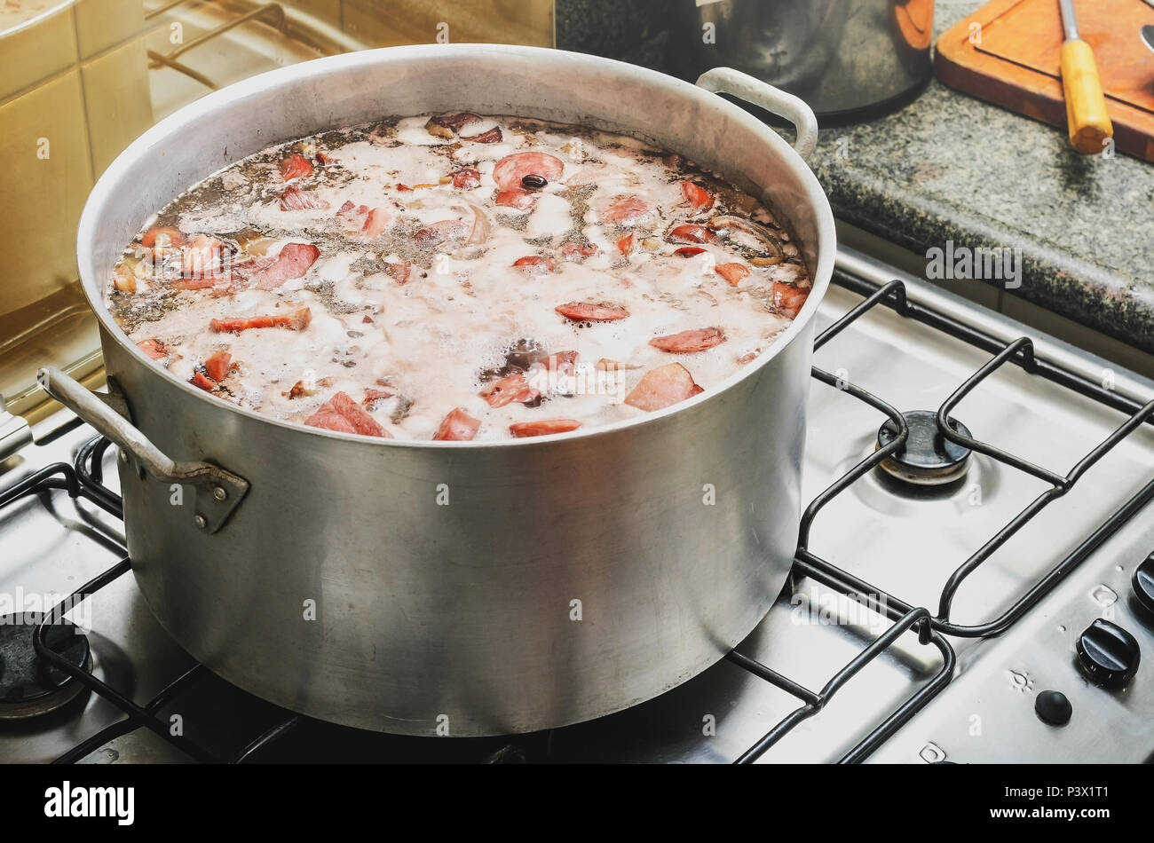 Cooking a big pan of Feijoada. Typical Brazilian cuisine, Feijoada has ...