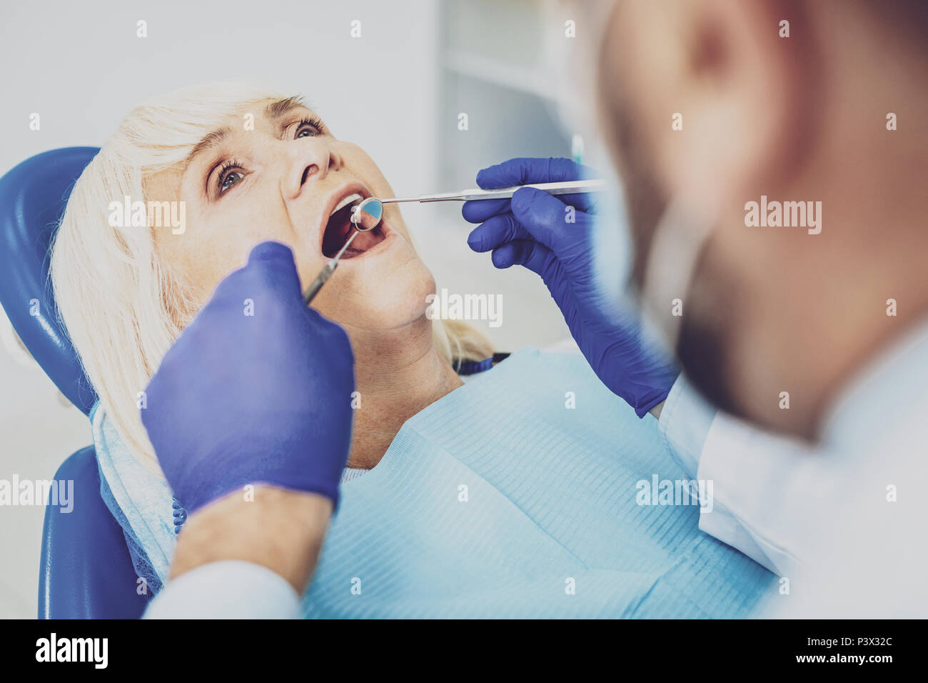 Professional stomatologist examining his patient Stock Photo - Alamy